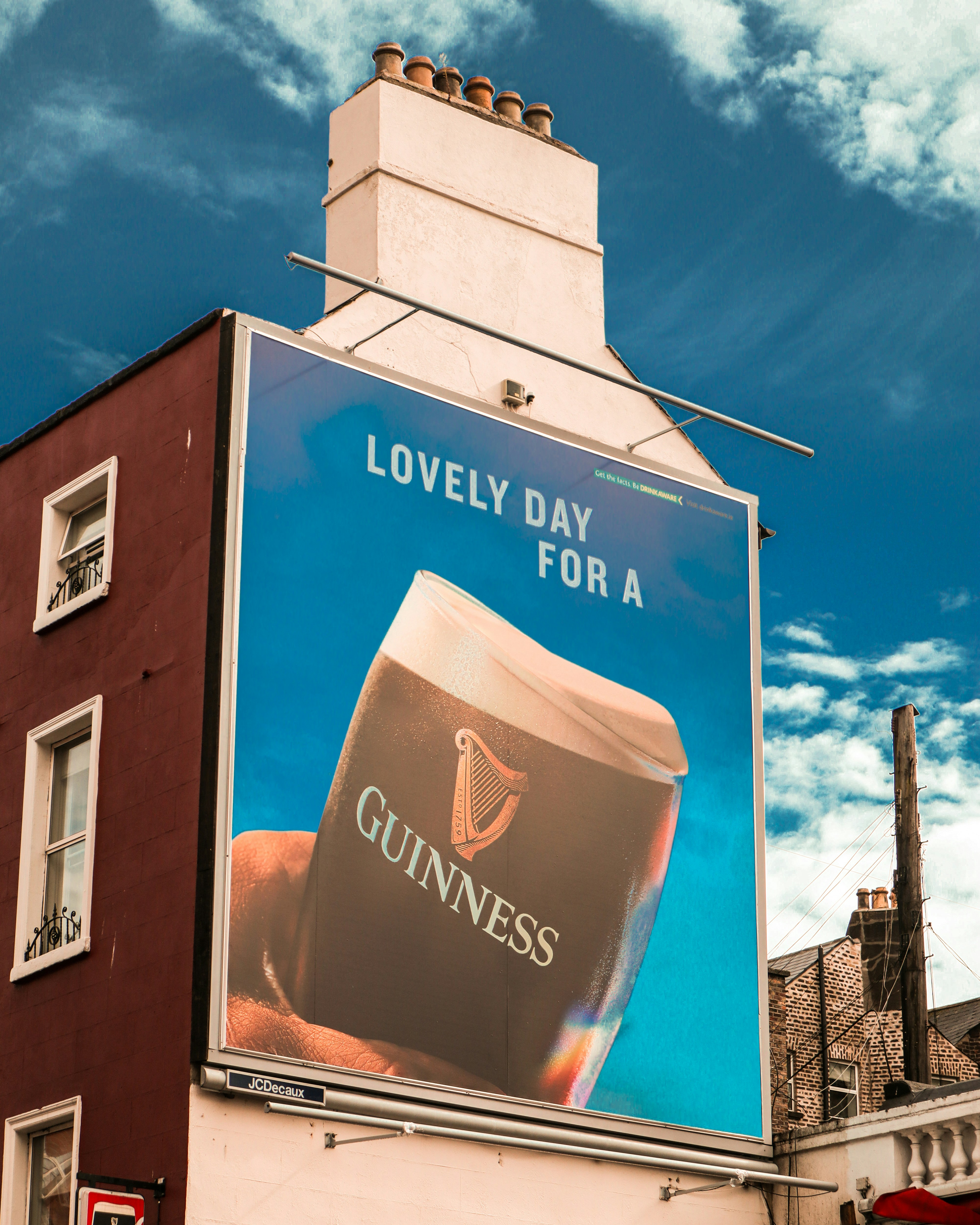 A large guinness advertisement on a building photo – Free Street Image ...