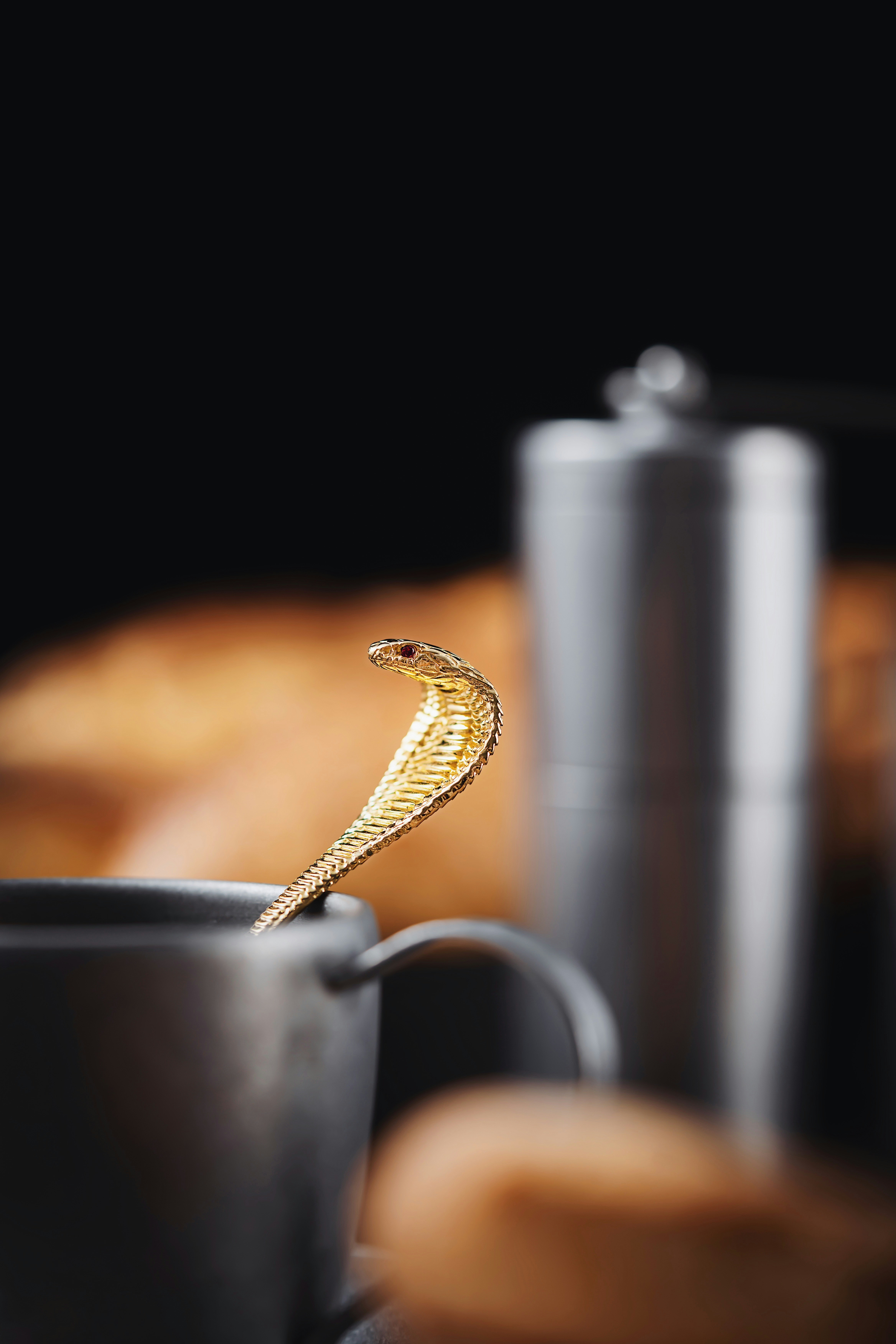 A golden snake sitting on top of a cup of coffee photo – Free Cup Image ...
