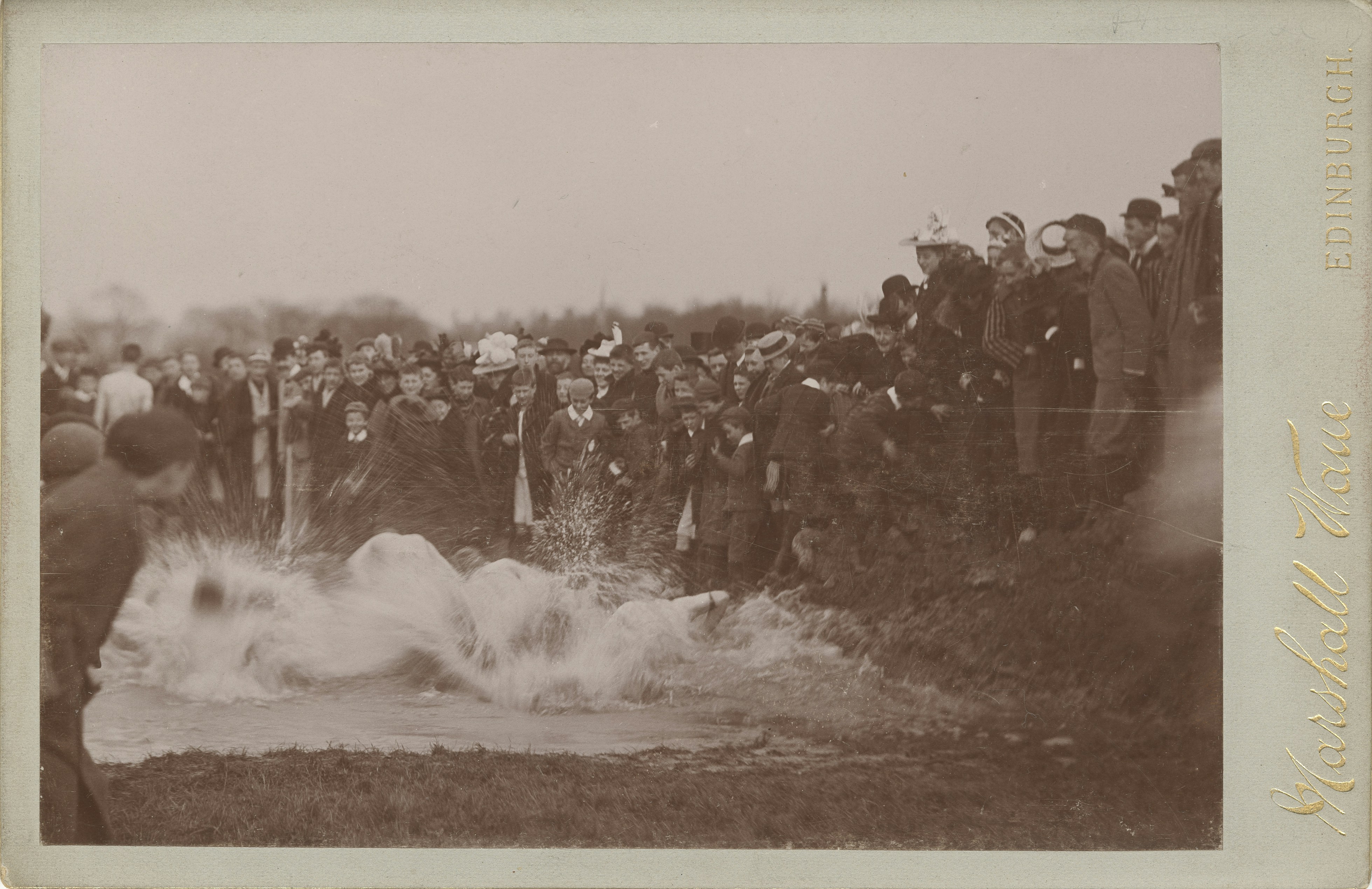 A group of people standing around a fire hydrant photo – Free People ...