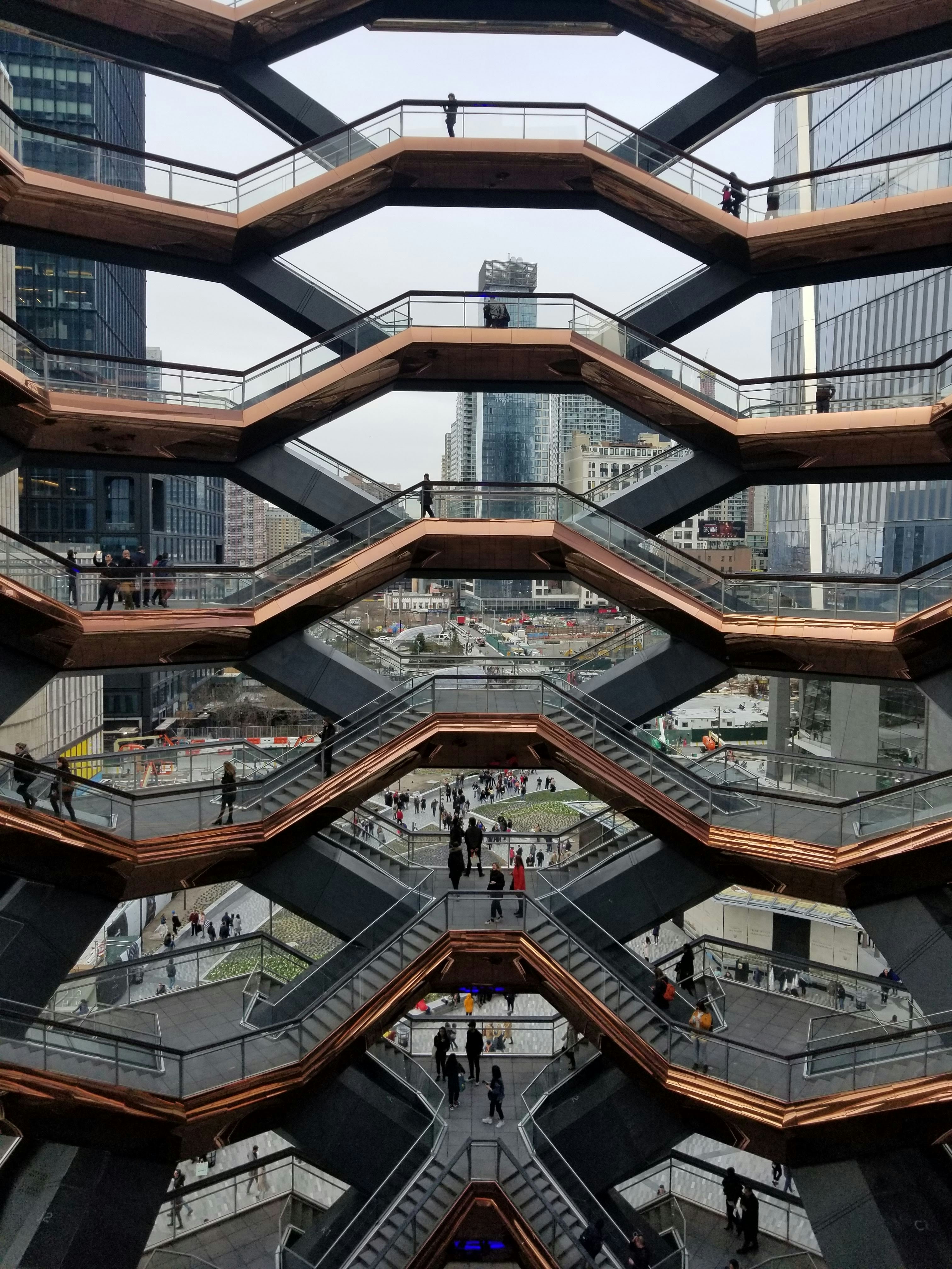 A group of people walking around a building photo – Free Vessel Image ...