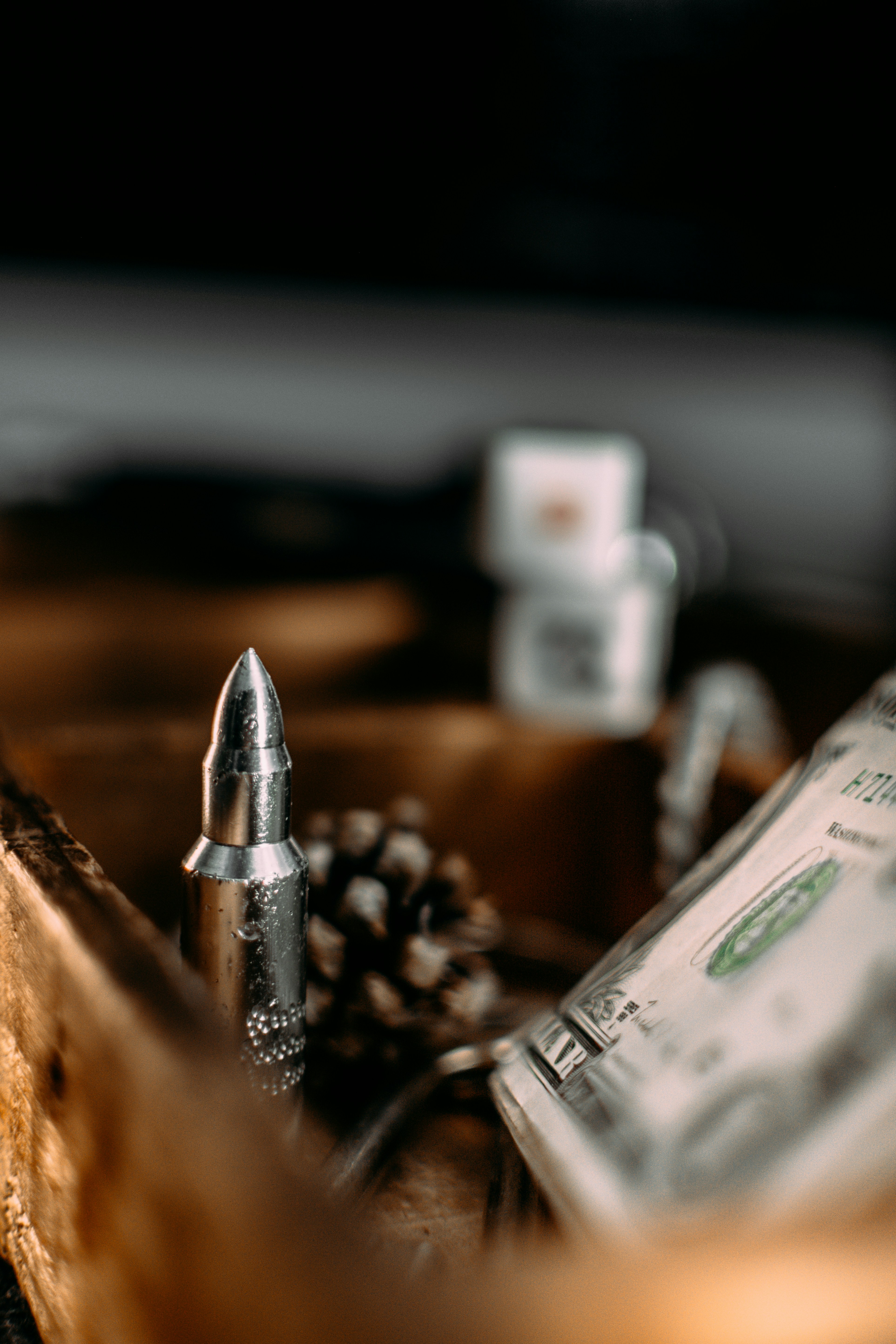 a bullet and some money sitting on a table