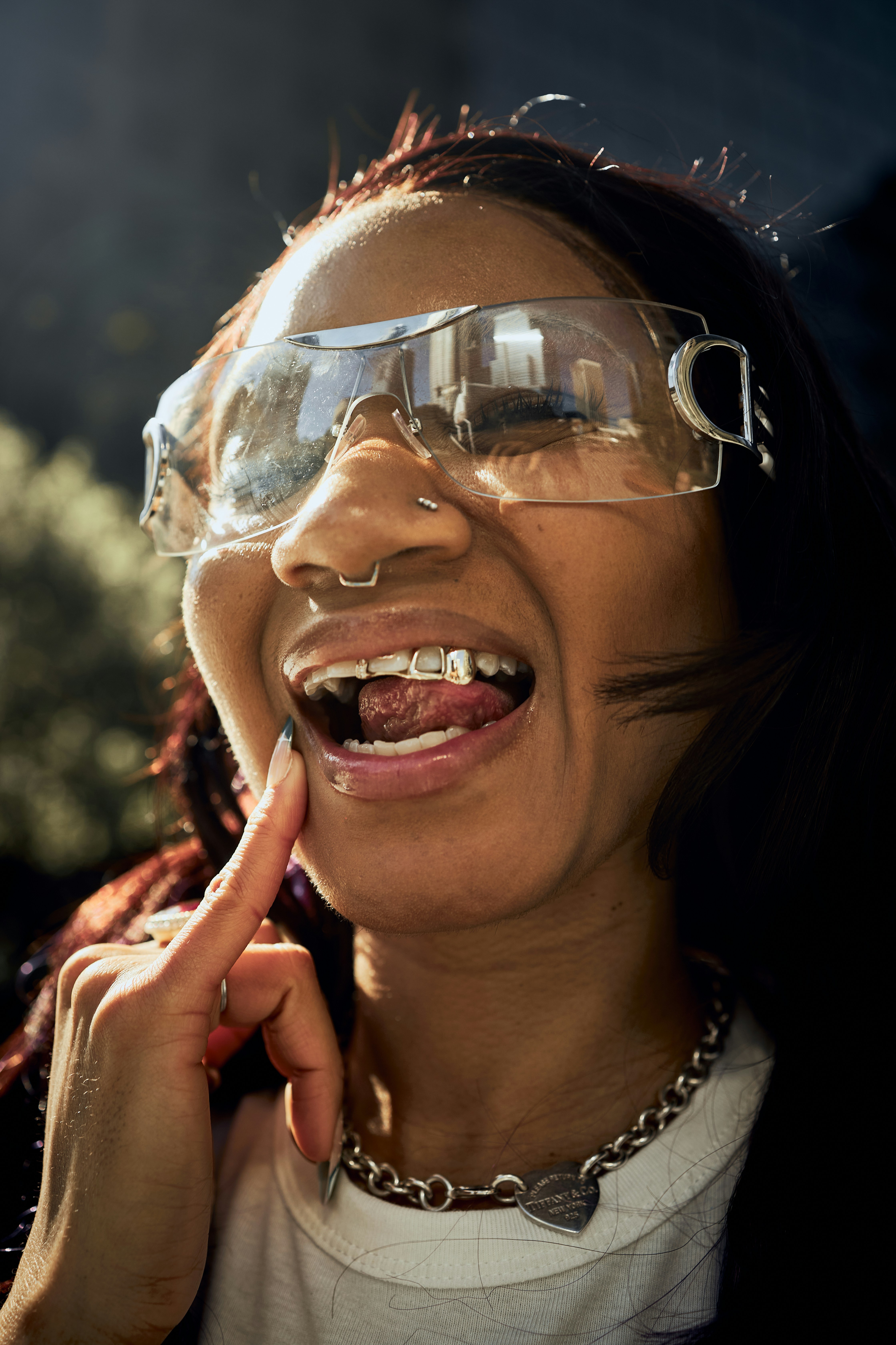 Gleeful Moment: A Sunglass-Scratched Smile in Bright Afternoon Light
