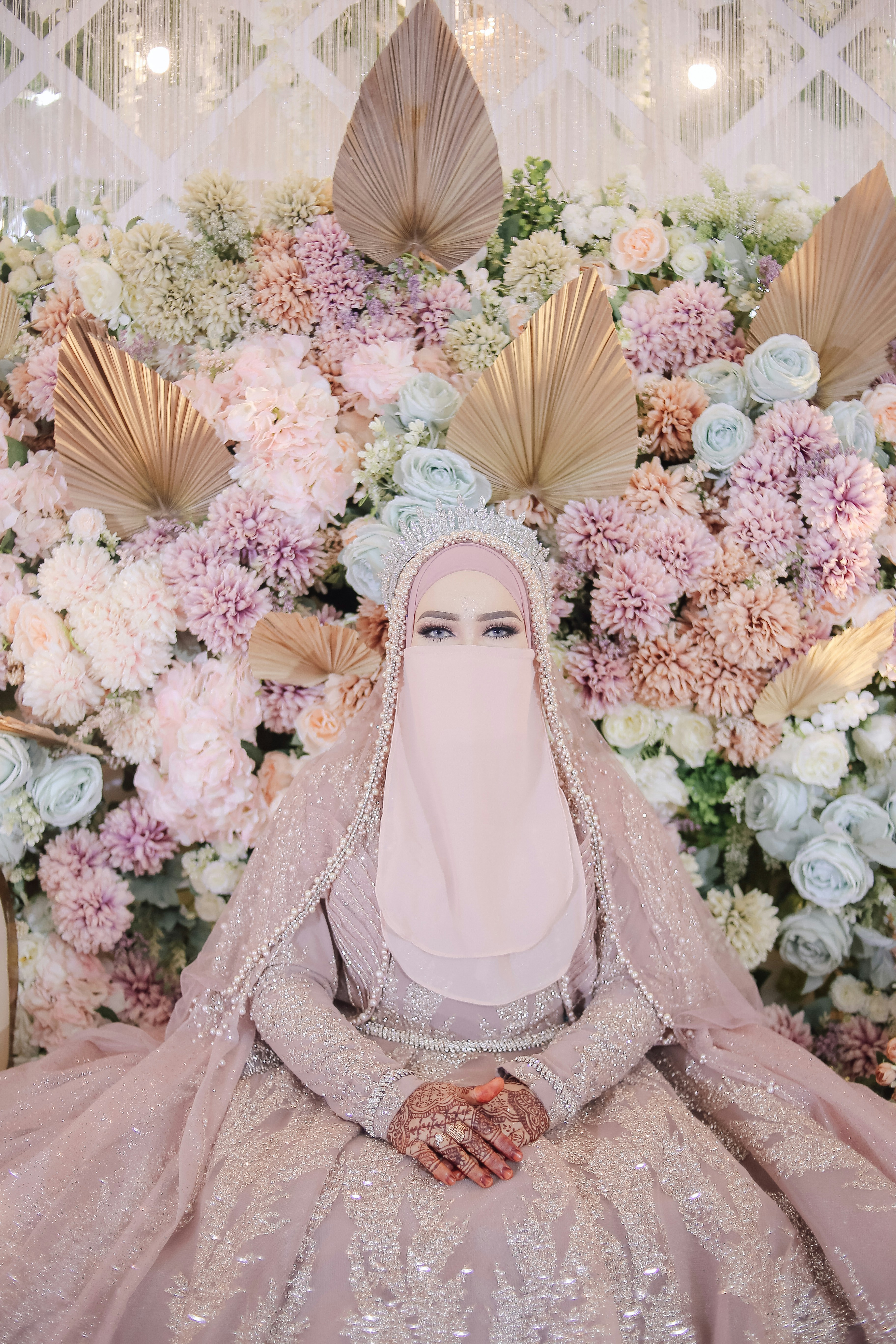 Veiled Grace: Bride in Soft Blush Amid Floral Reverie