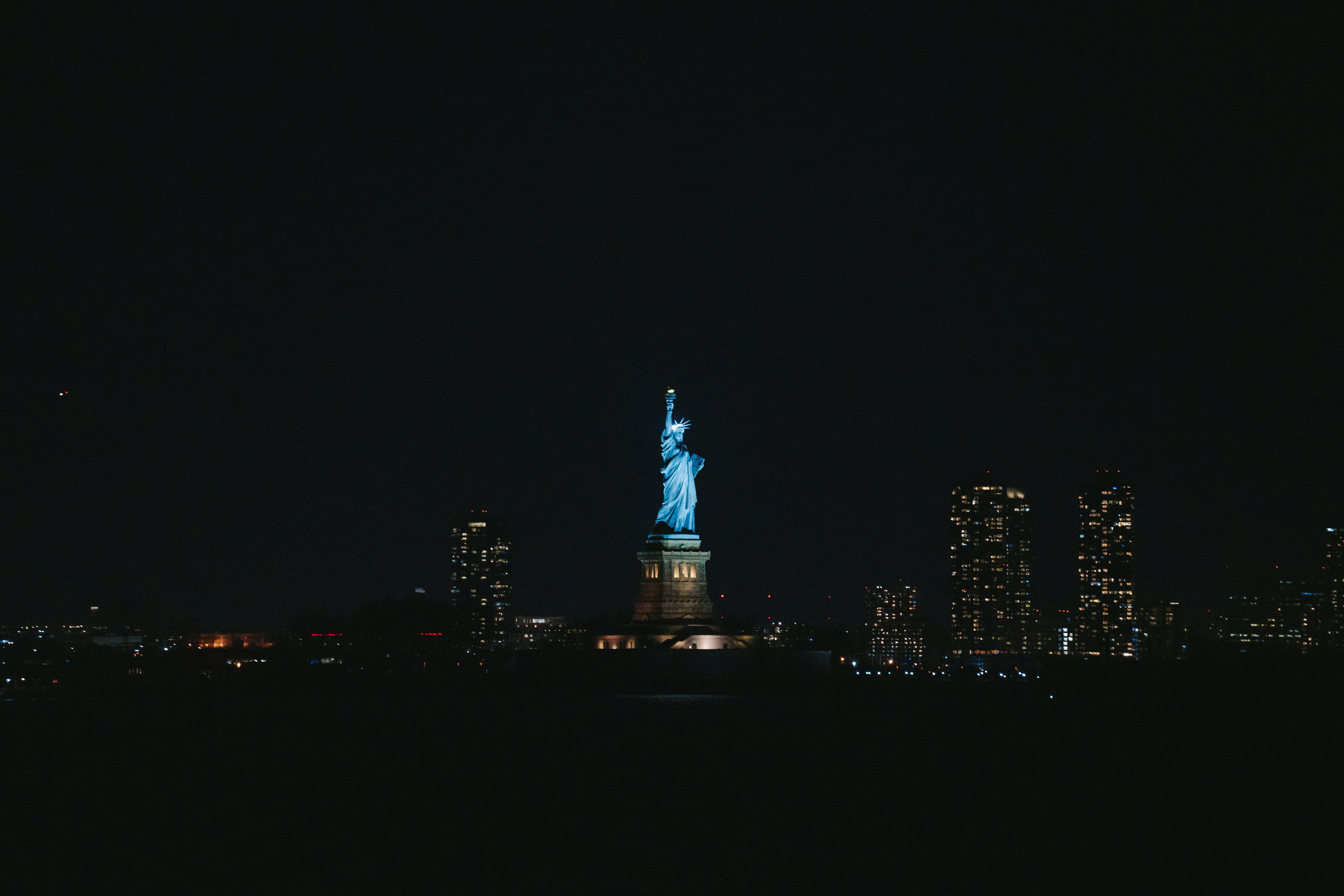 The statue of liberty lit up at night photo – Free New york Image on ...