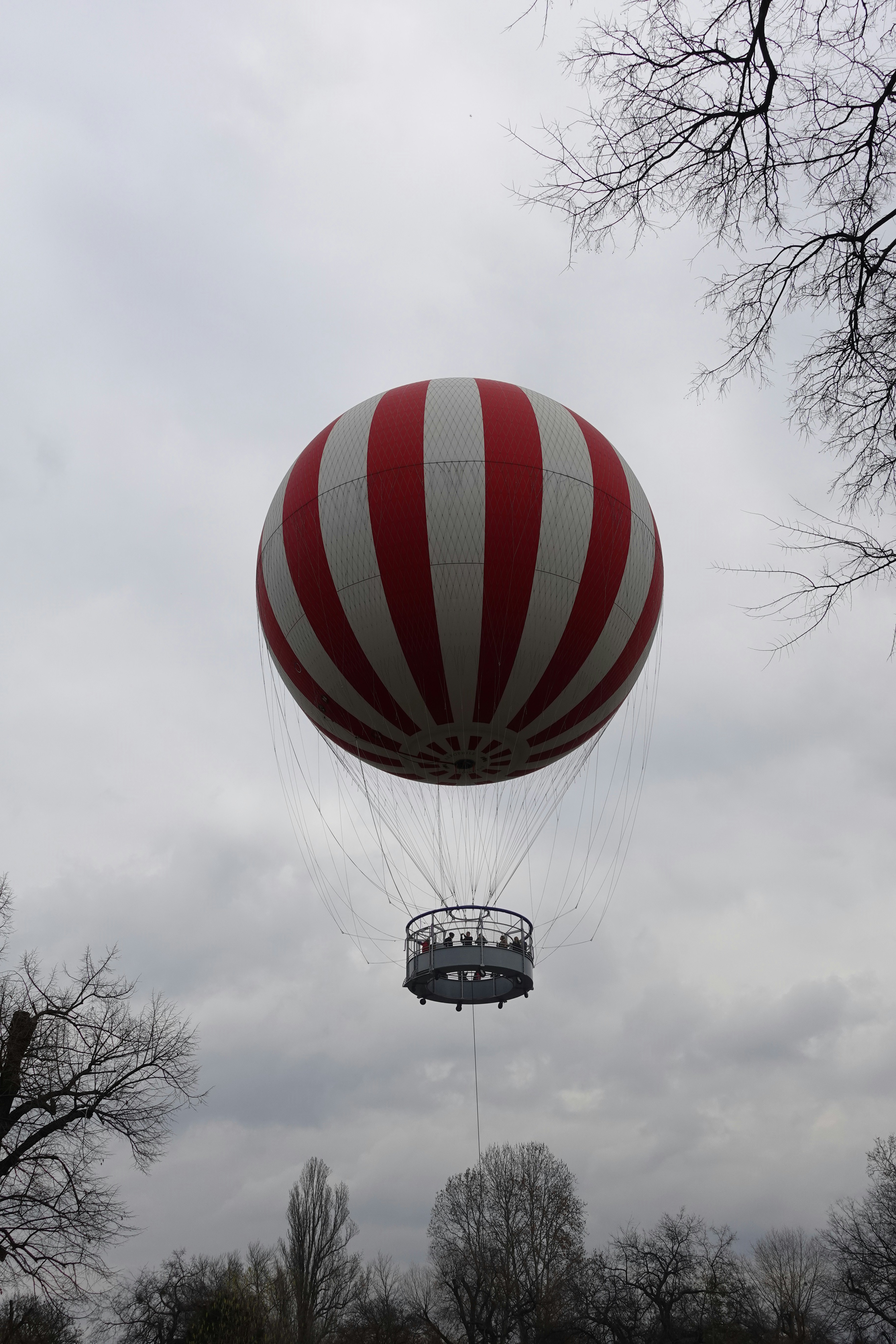 Red-Striped Balloon Over a Quiet Park: Gondola Lift in Overcast Light
