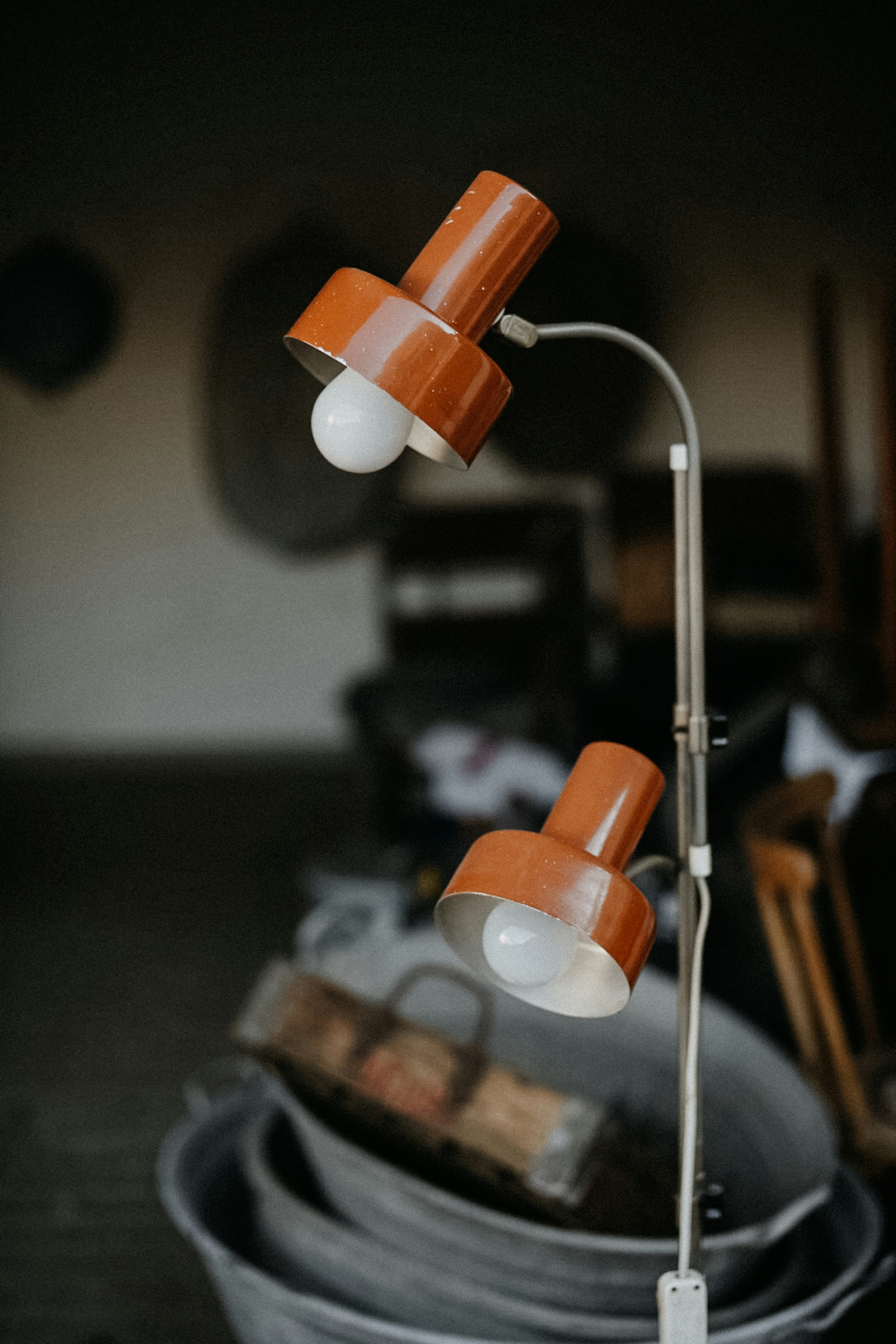 Tilted Orange Lamp Duo in a Quiet Studio