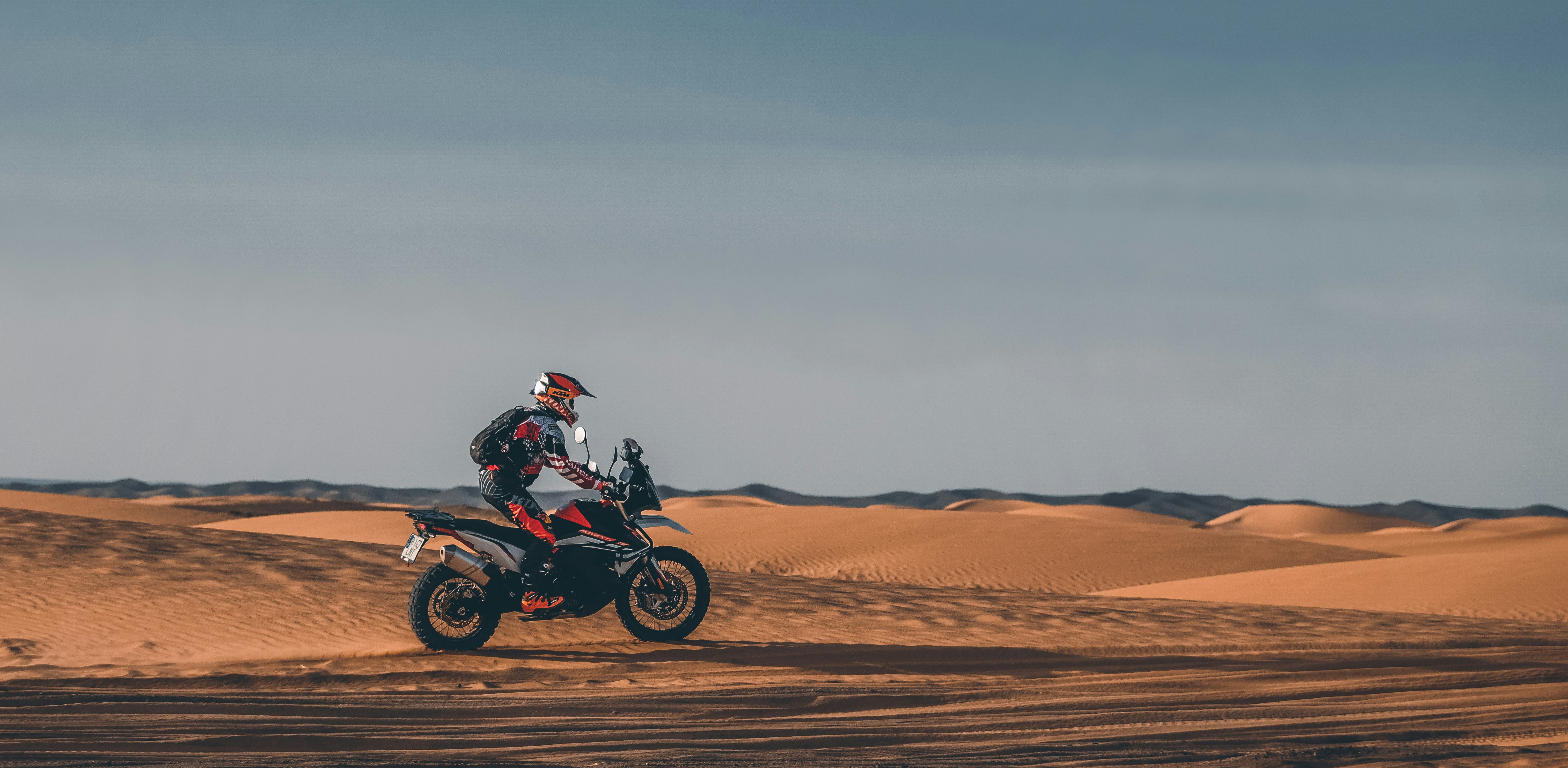 A person riding a motorcycle in the desert photo – Free Sahara desert ...