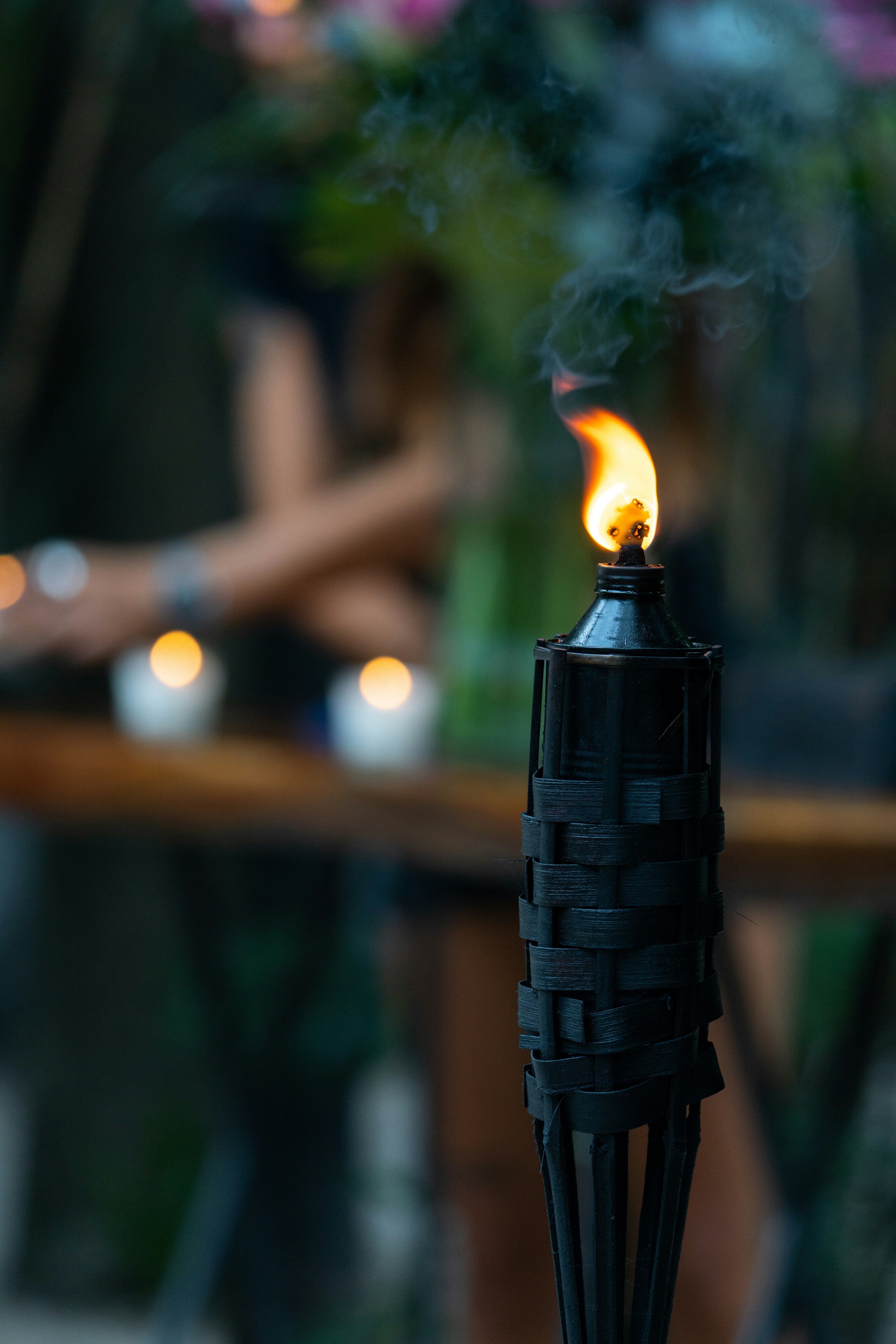 Flame sentinel: a tiki torch leads the quiet dusk ritual