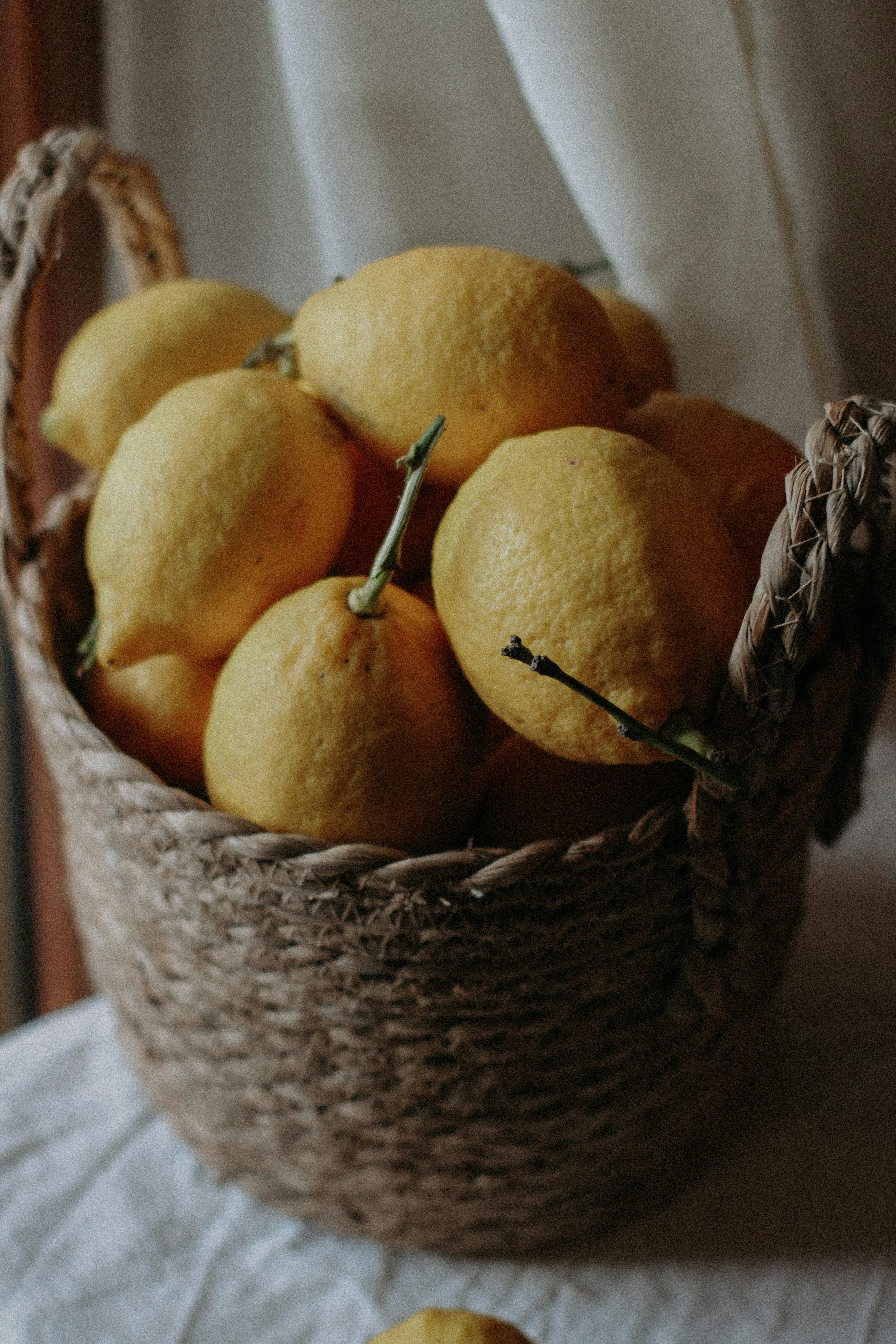 A basket filled with lemons sitting on top of a table photo – Free ...