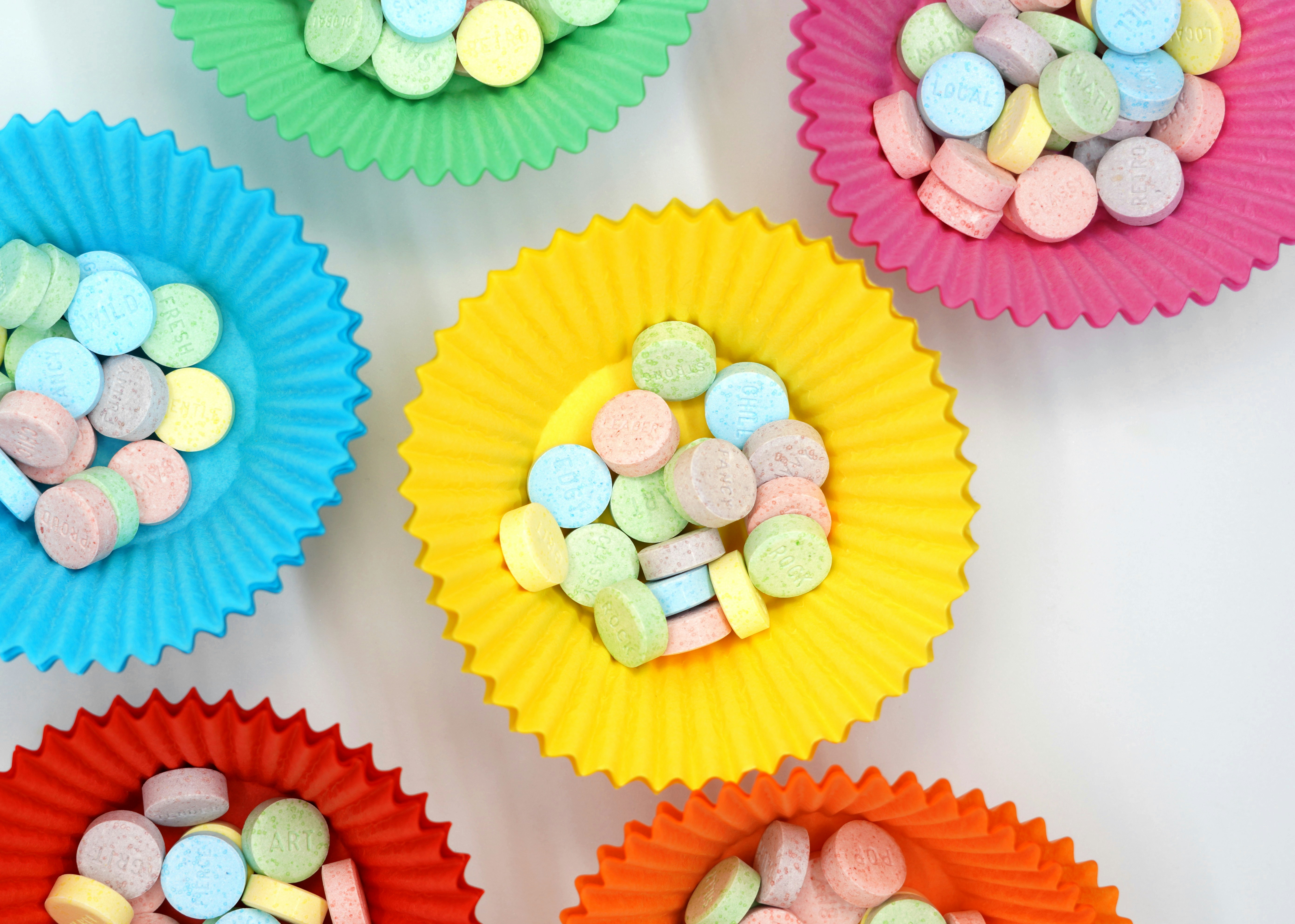 A group of colorful paper plates filled with candy photo – Free Sweets ...