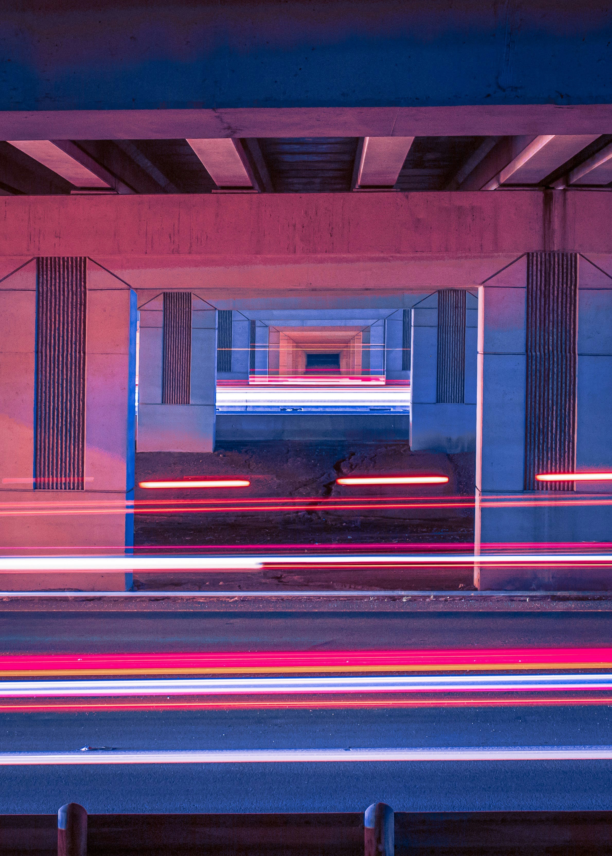 Vaporwave-like long exposure shot of an underpass as cars passed by.
