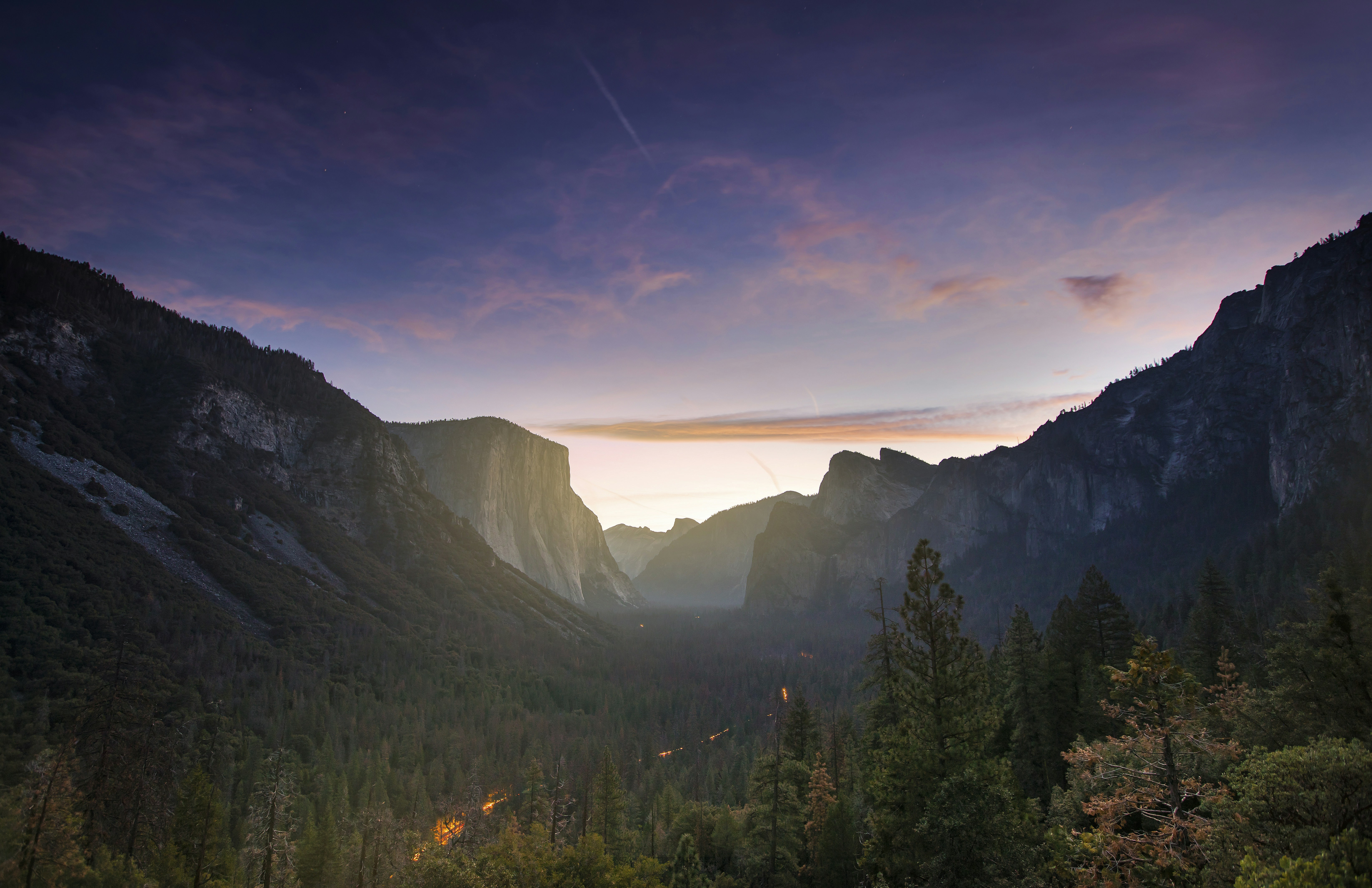 Horizon Fire Over a Pine-Clad Canyon at Dusk