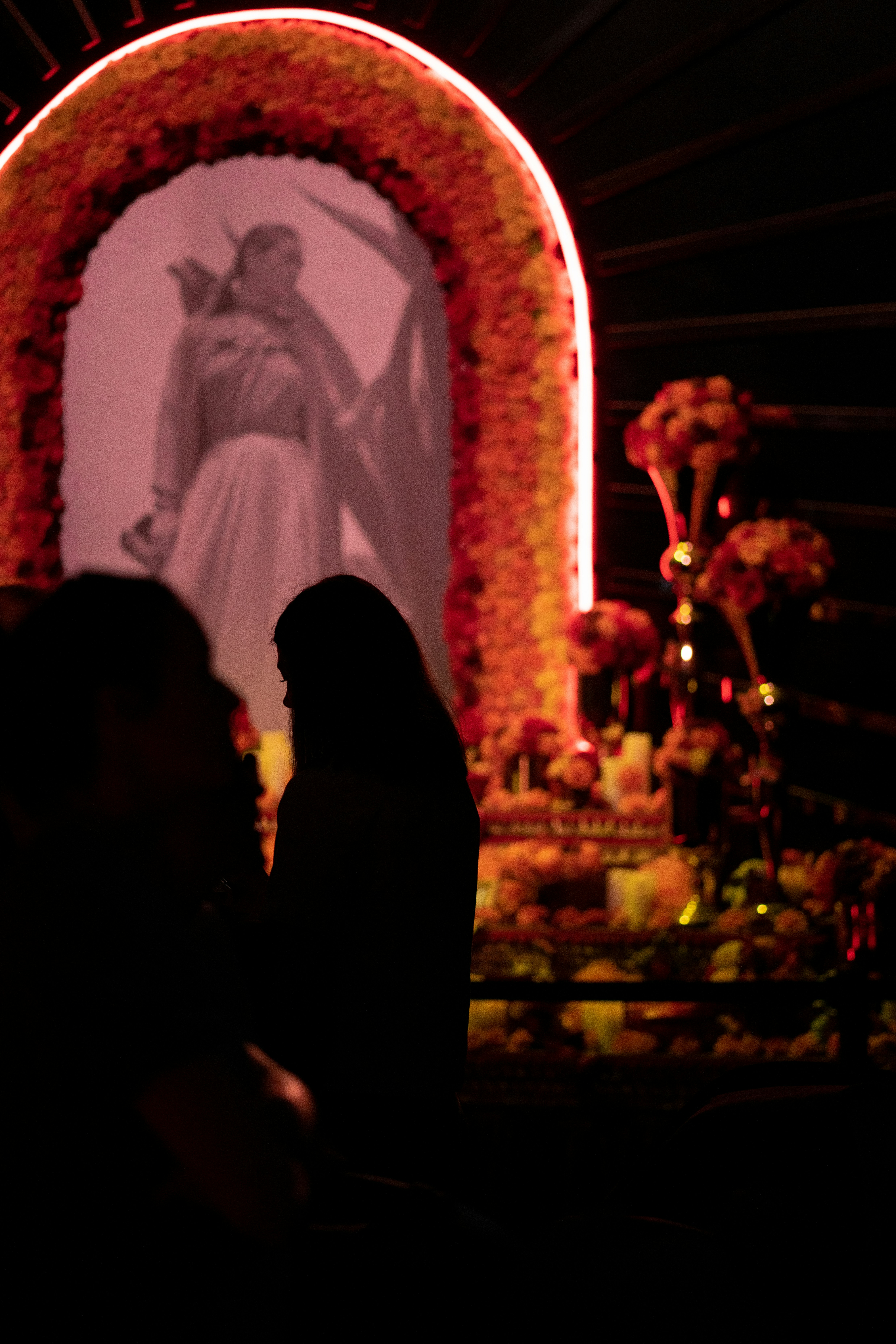 Crimson Arch Shrine: Silhouettes Framing a Backlit Statue