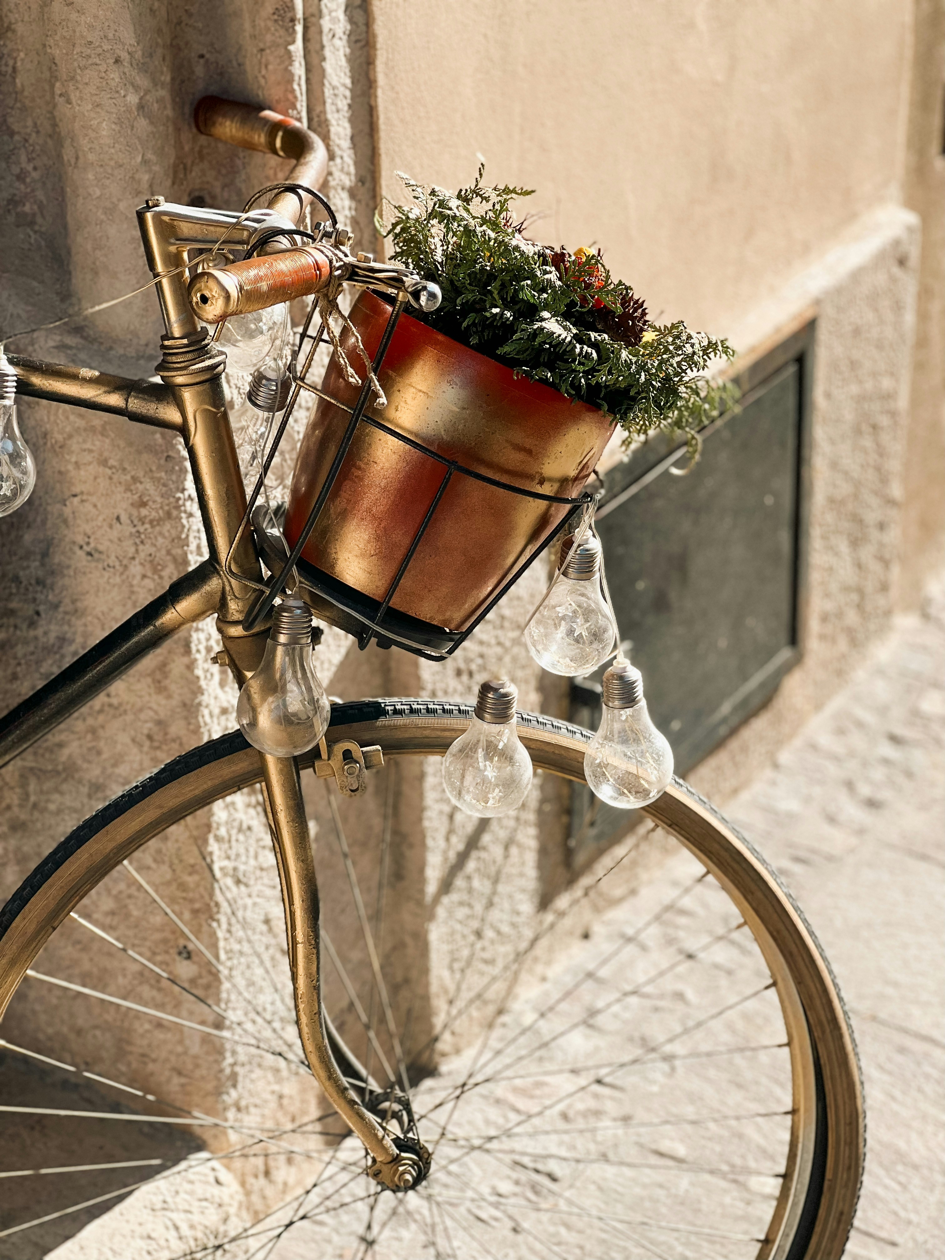 Gold bicycle with a flower basket in an aged alley