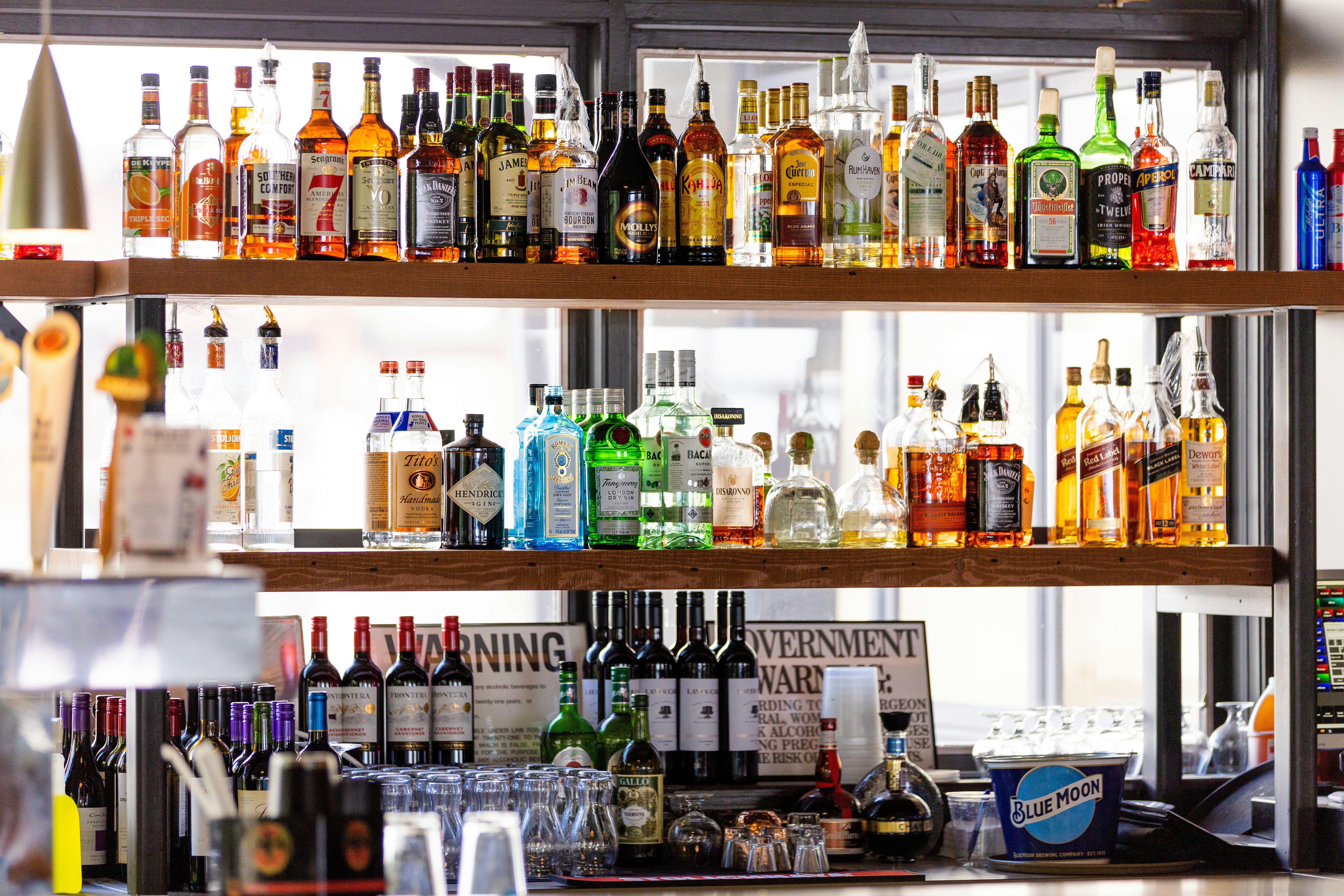 A bar filled with lots of bottles of alcohol photo – Free Windham ...