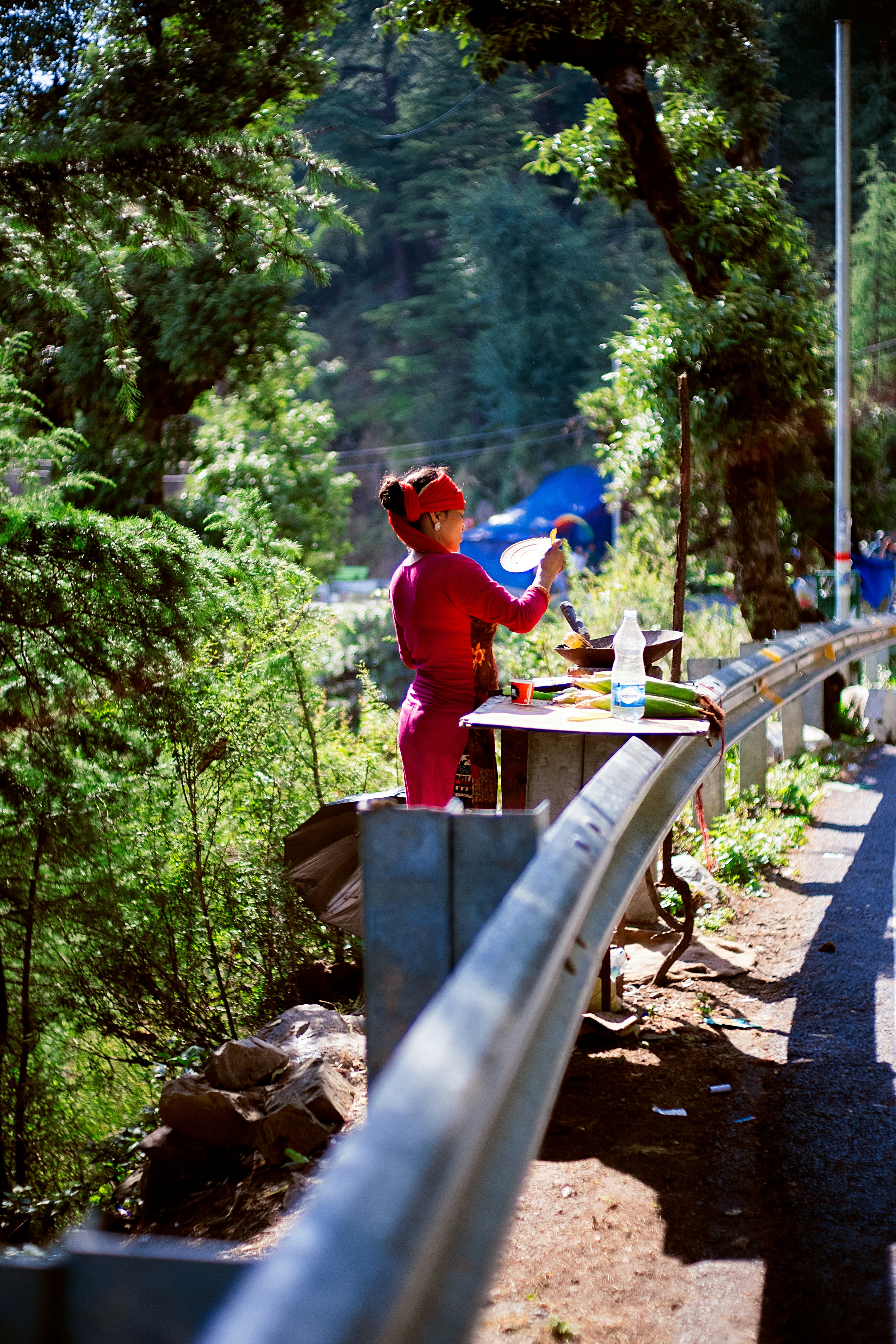 Red-Sleeved Vendor at a Sunny Mountain Path