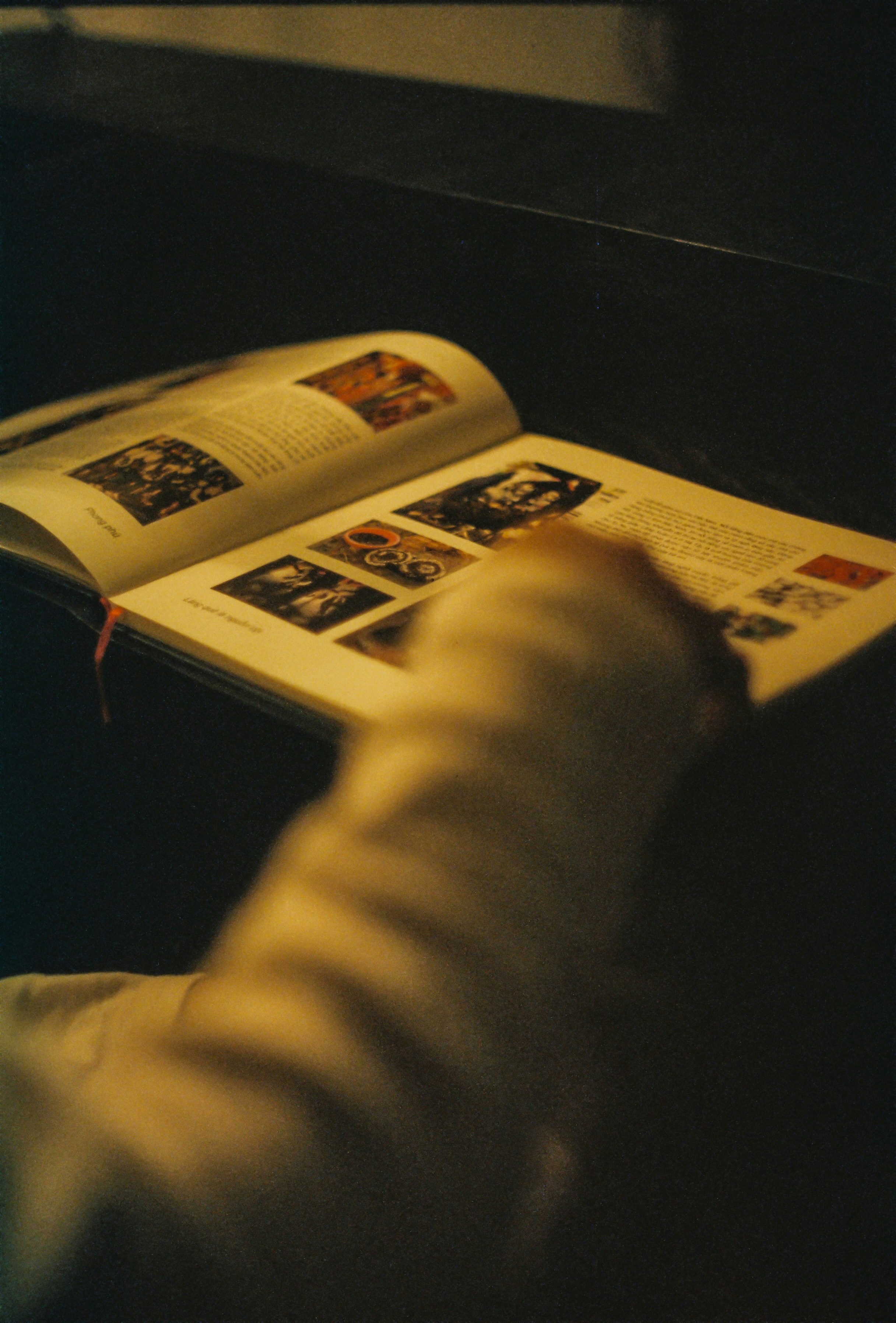 a person is reading a book in a dark room