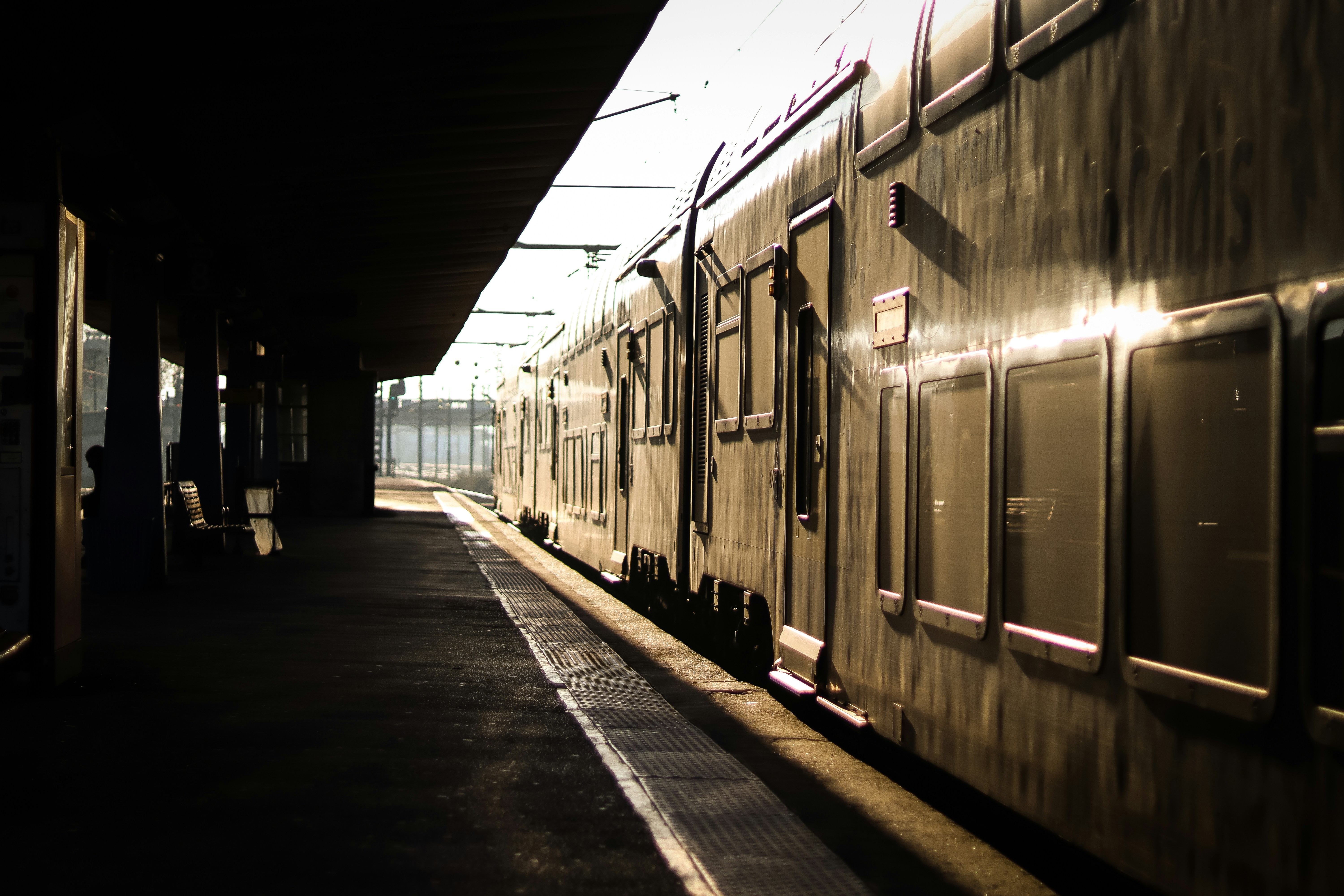 A train parked at a train station next to a platform photo – Free Train ...