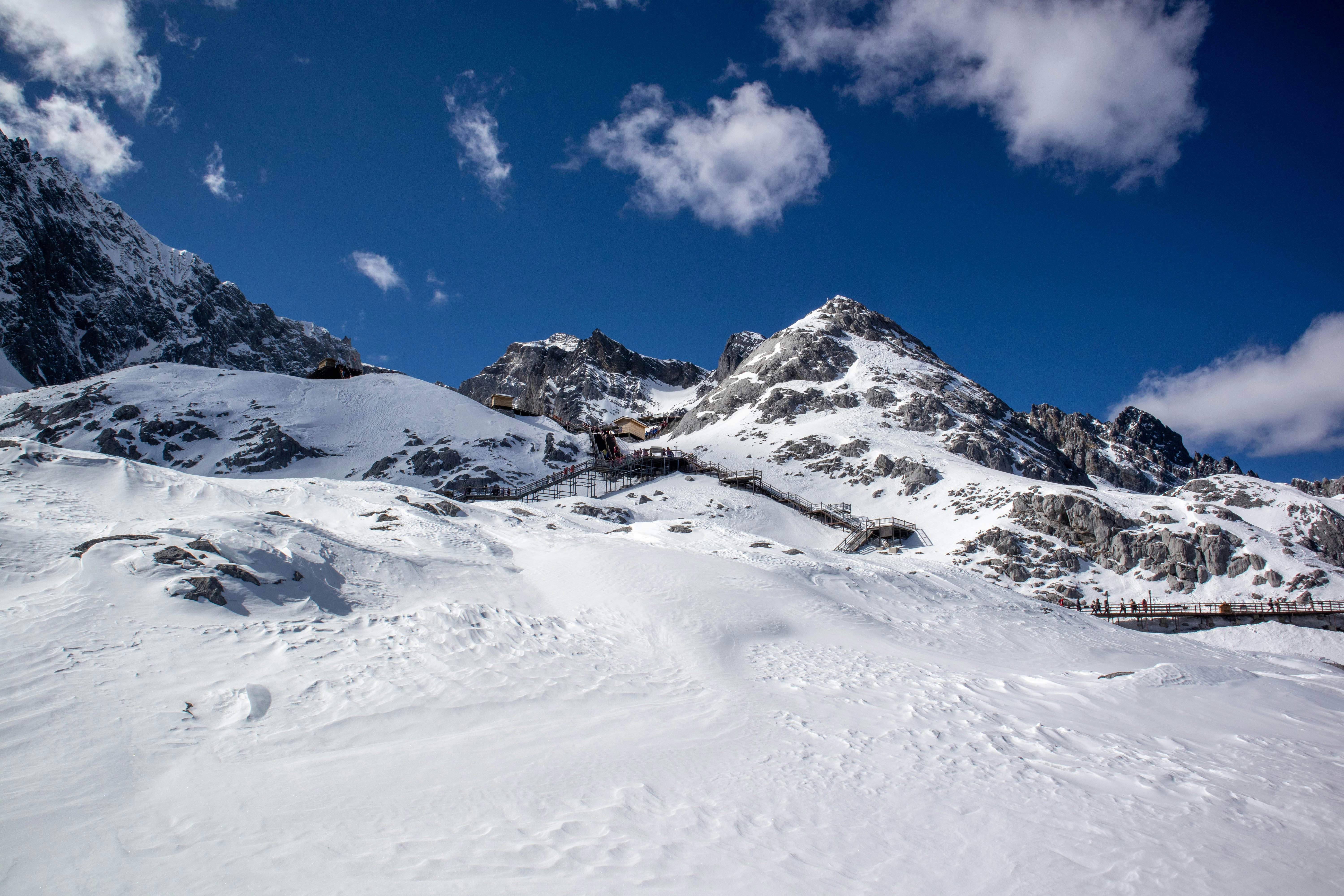 A mountain covered in snow under a blue sky photo – Free Jade dragon ...