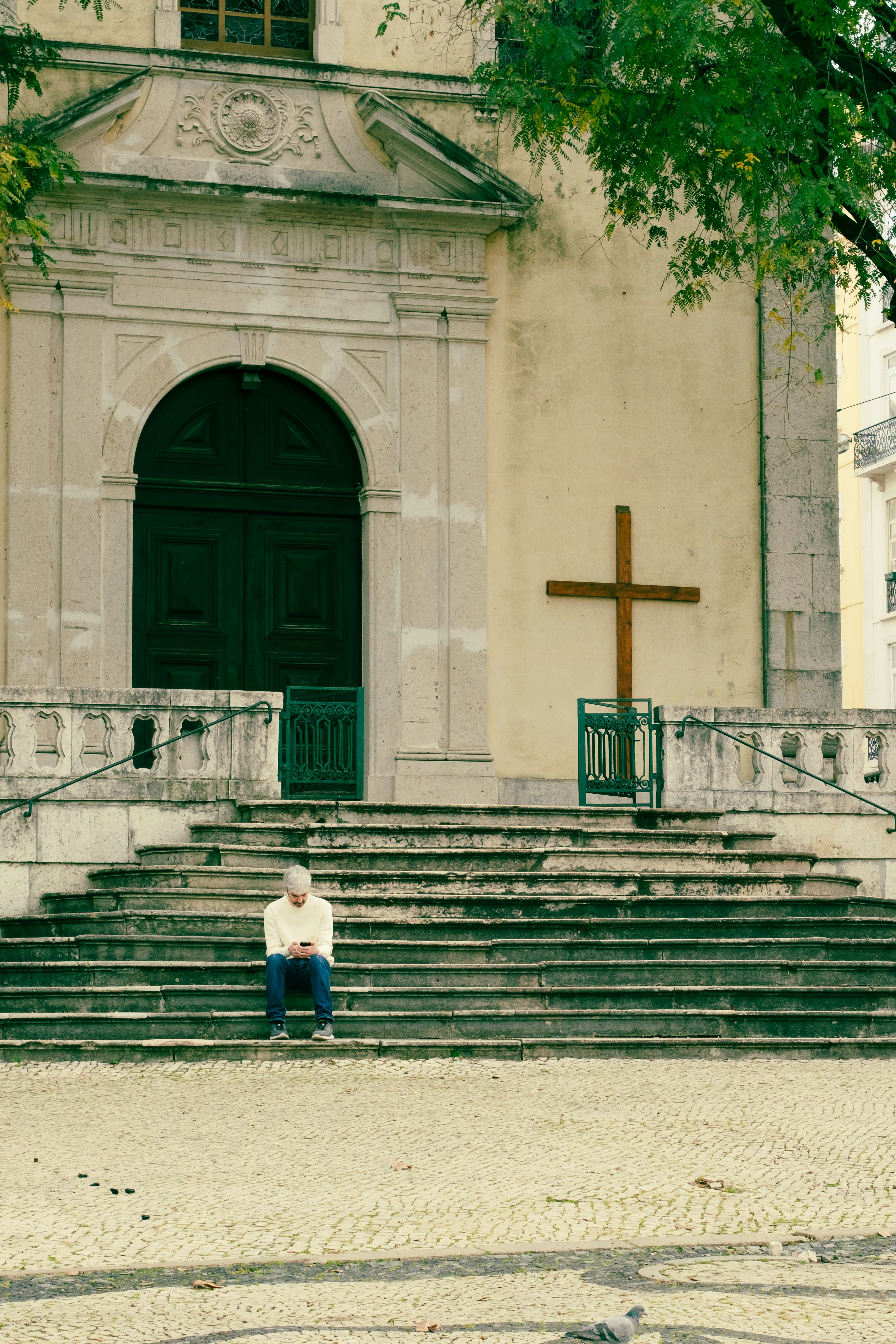 A man sitting on the steps of a church photo – Free Lisbon Image on ...