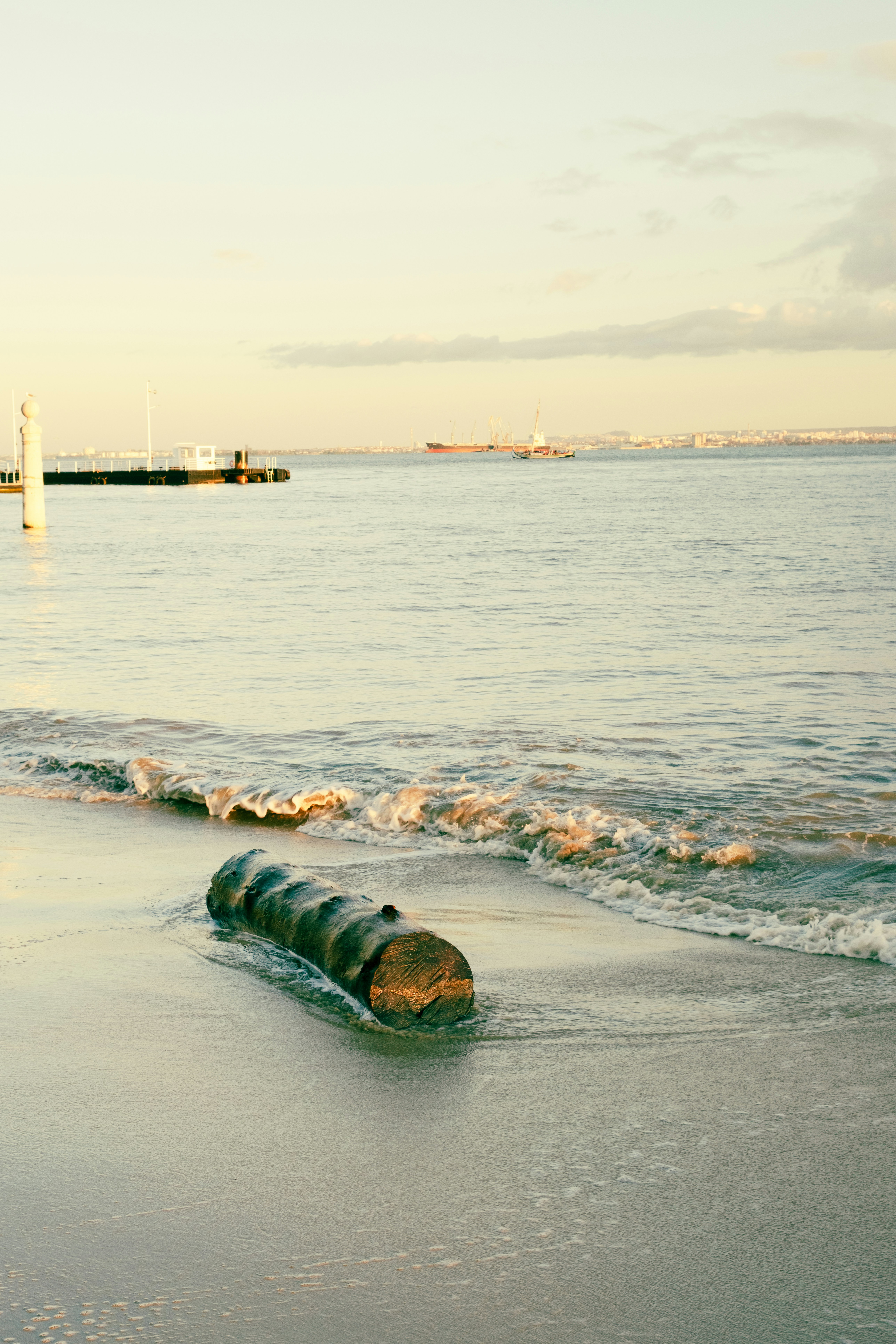 A large pipe laying on top of a sandy beach photo – Free Portugal Image ...
