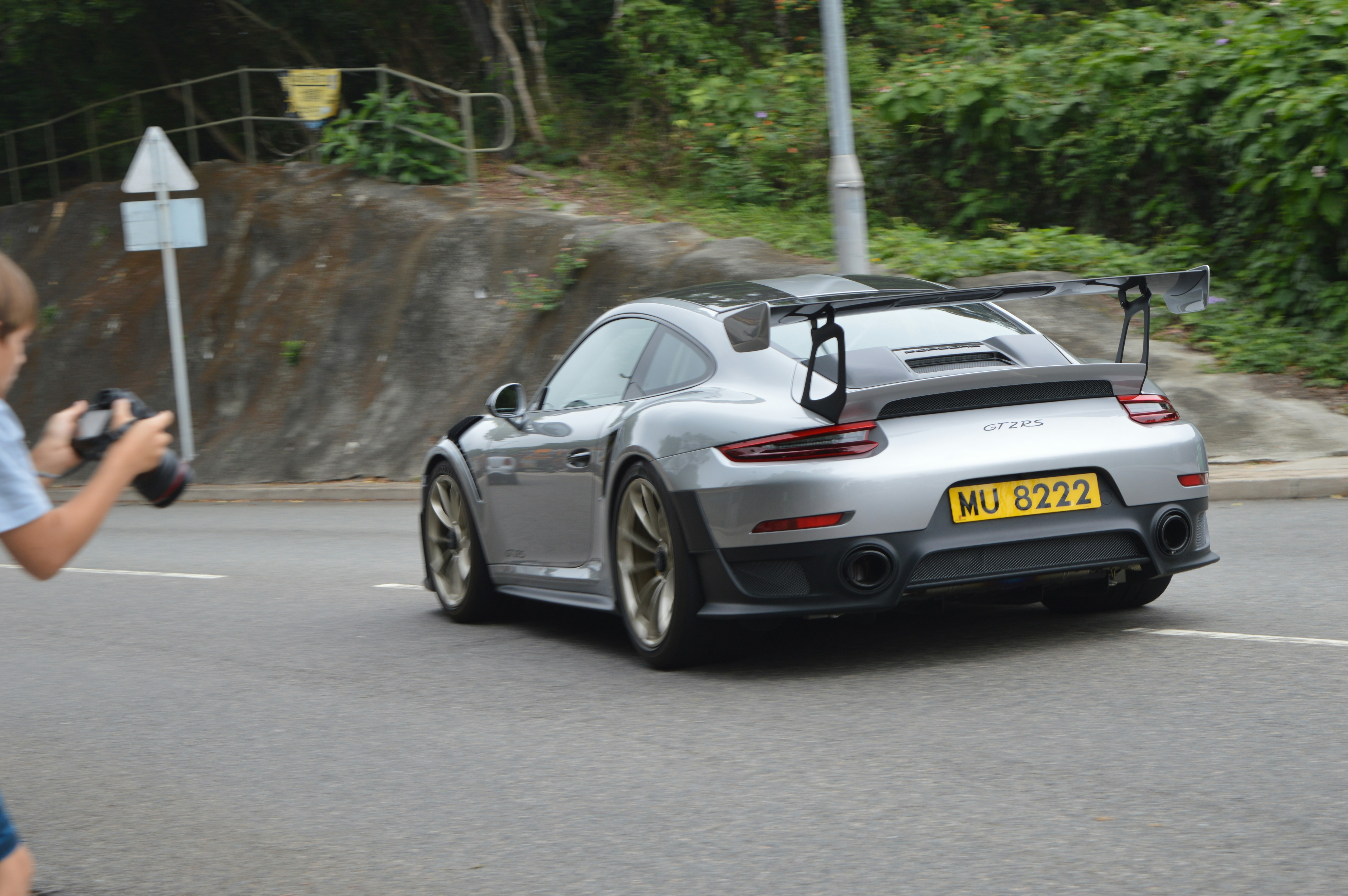 Rear-Quarter View of a Silver Porsche-Like Sports Car in Motion