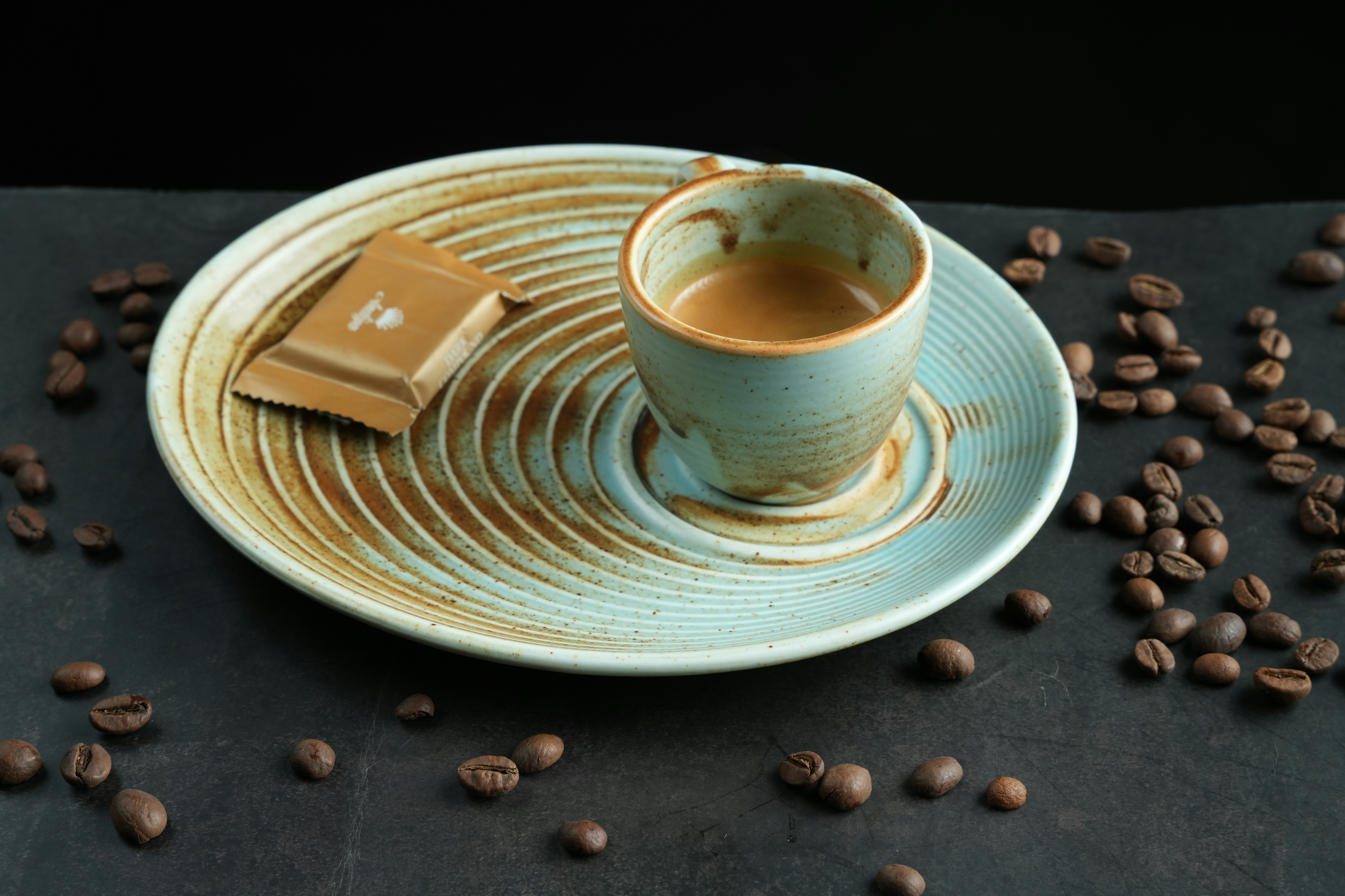 Ceramic Cup and Chocolate on a Spotted Plate: Quiet Coffee Moment