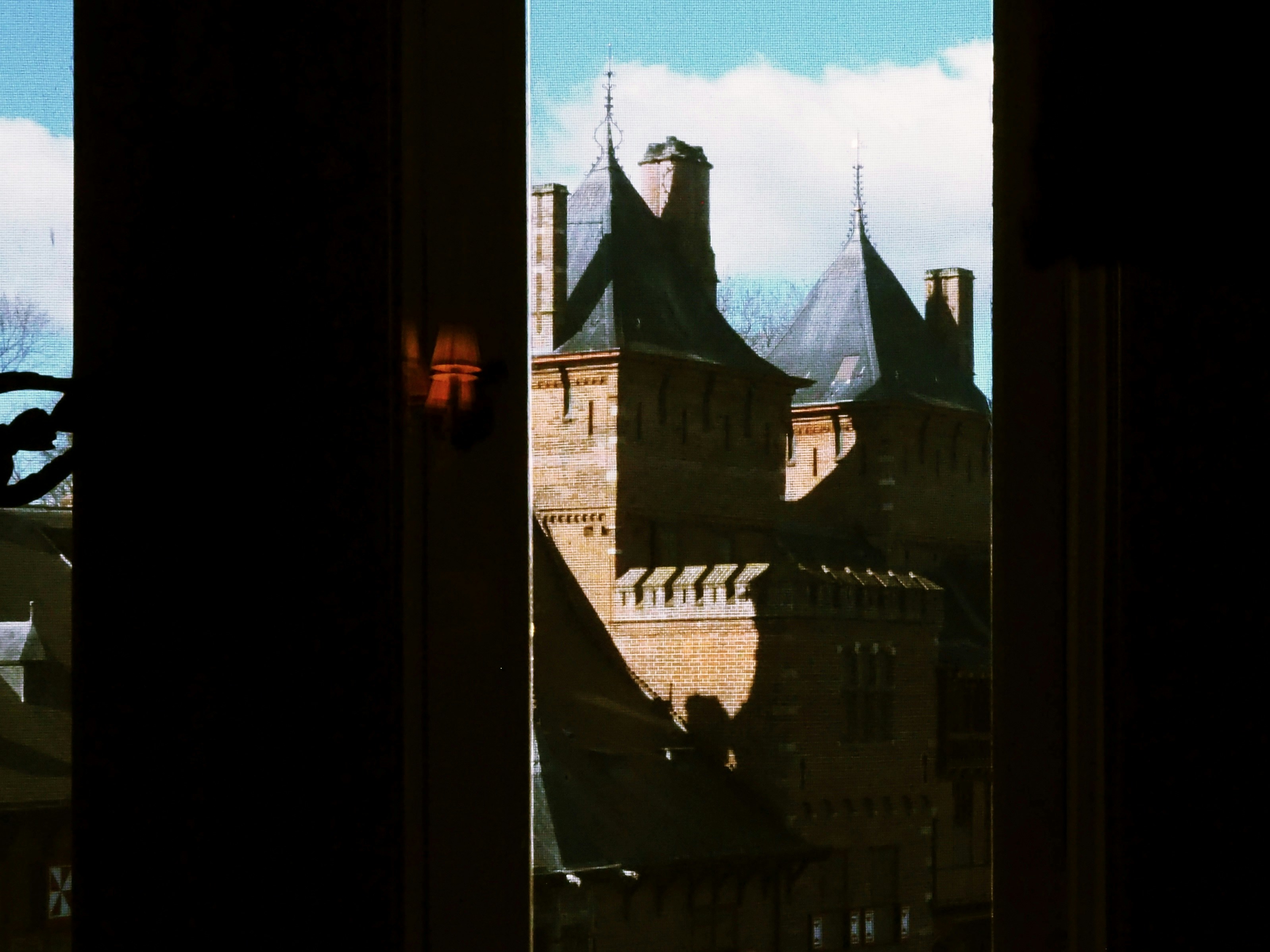 A view of a castle through a window photo – Free Building Image on Unsplash