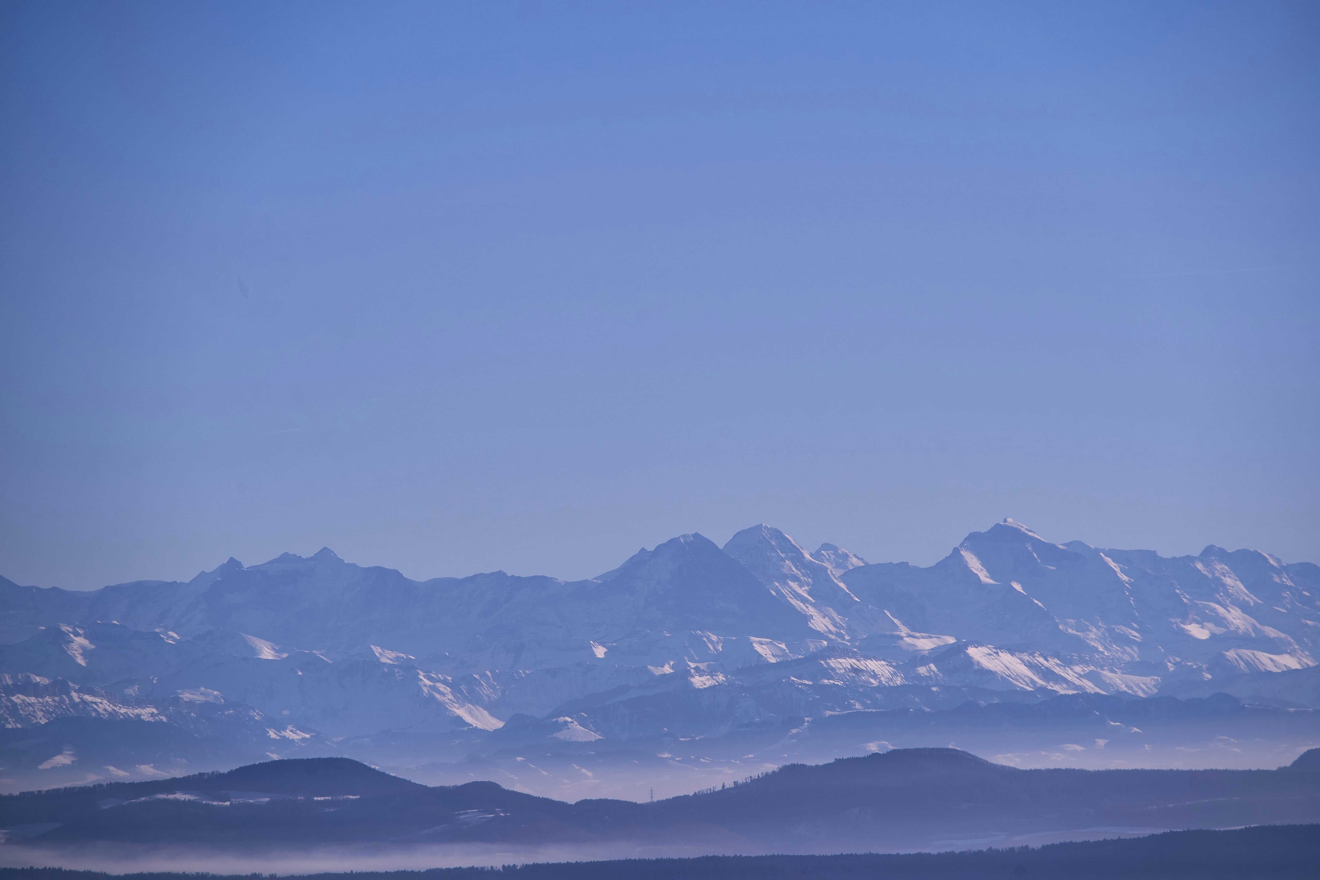 A view of a mountain range from a distance photo – Free Mountain Image ...