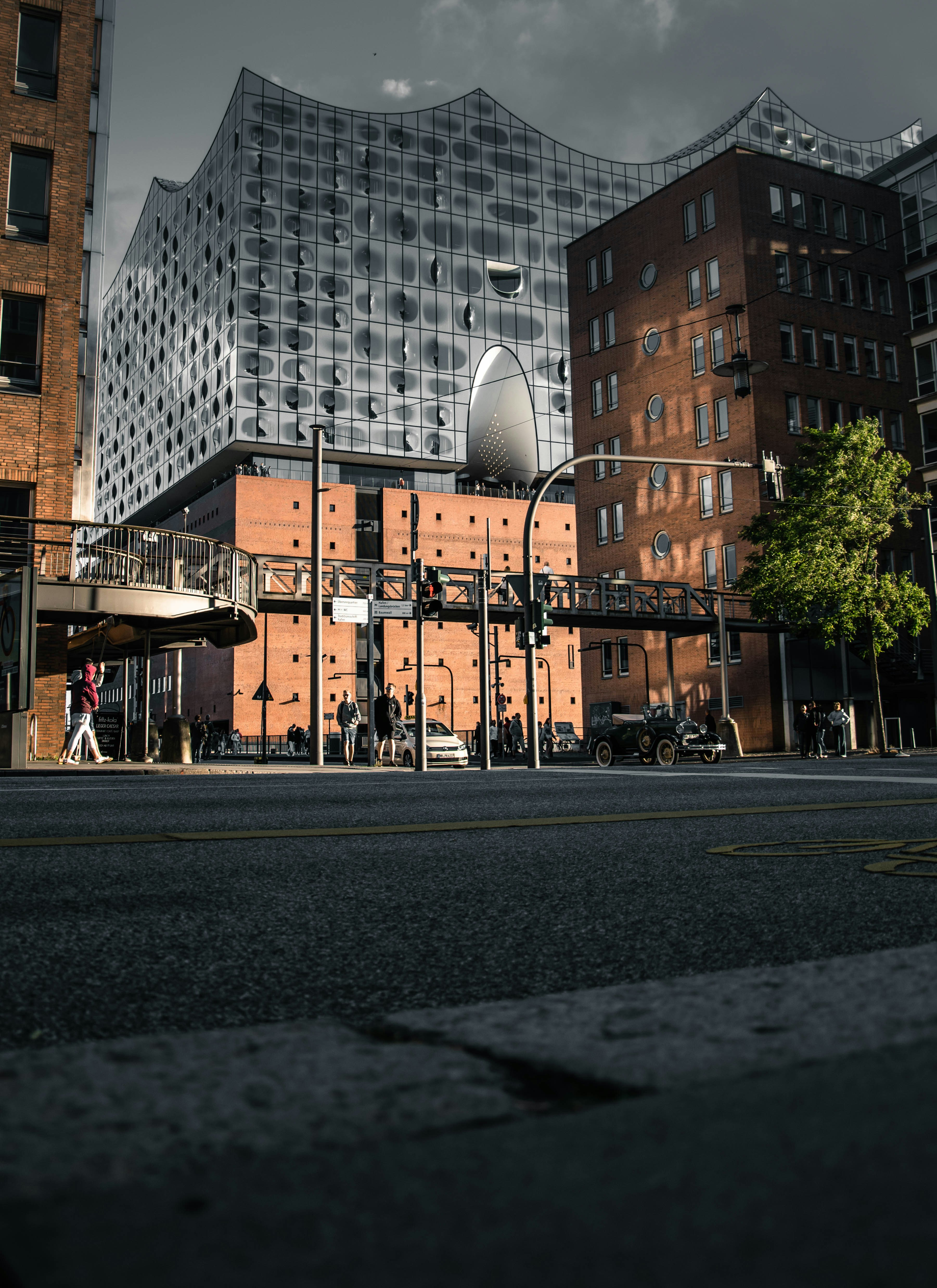 Bubble-Walled Skyline: The Curved Glass Fortress Over a Red-Brick Street