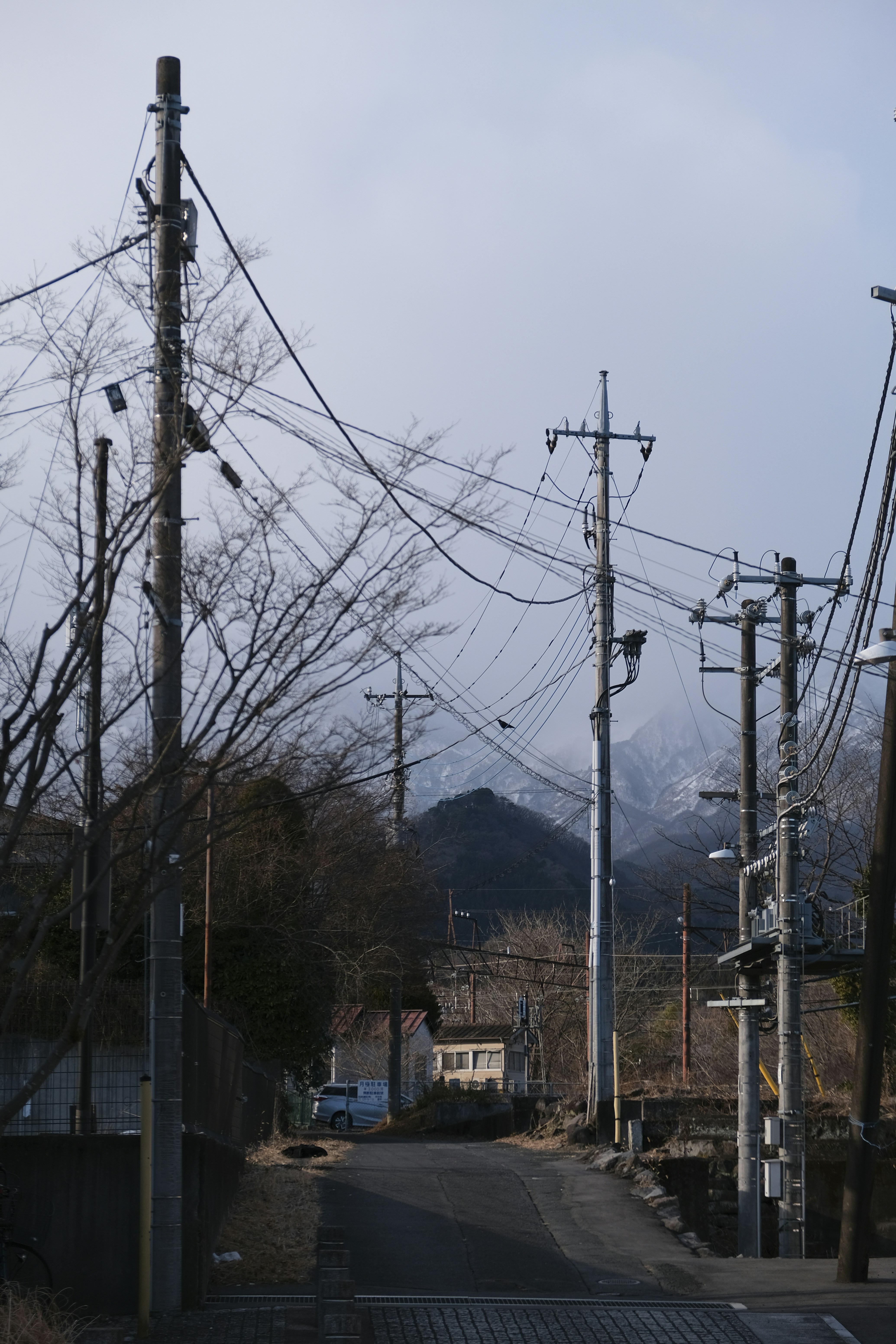 Foggy Mountains and Power Poles in a Small Street