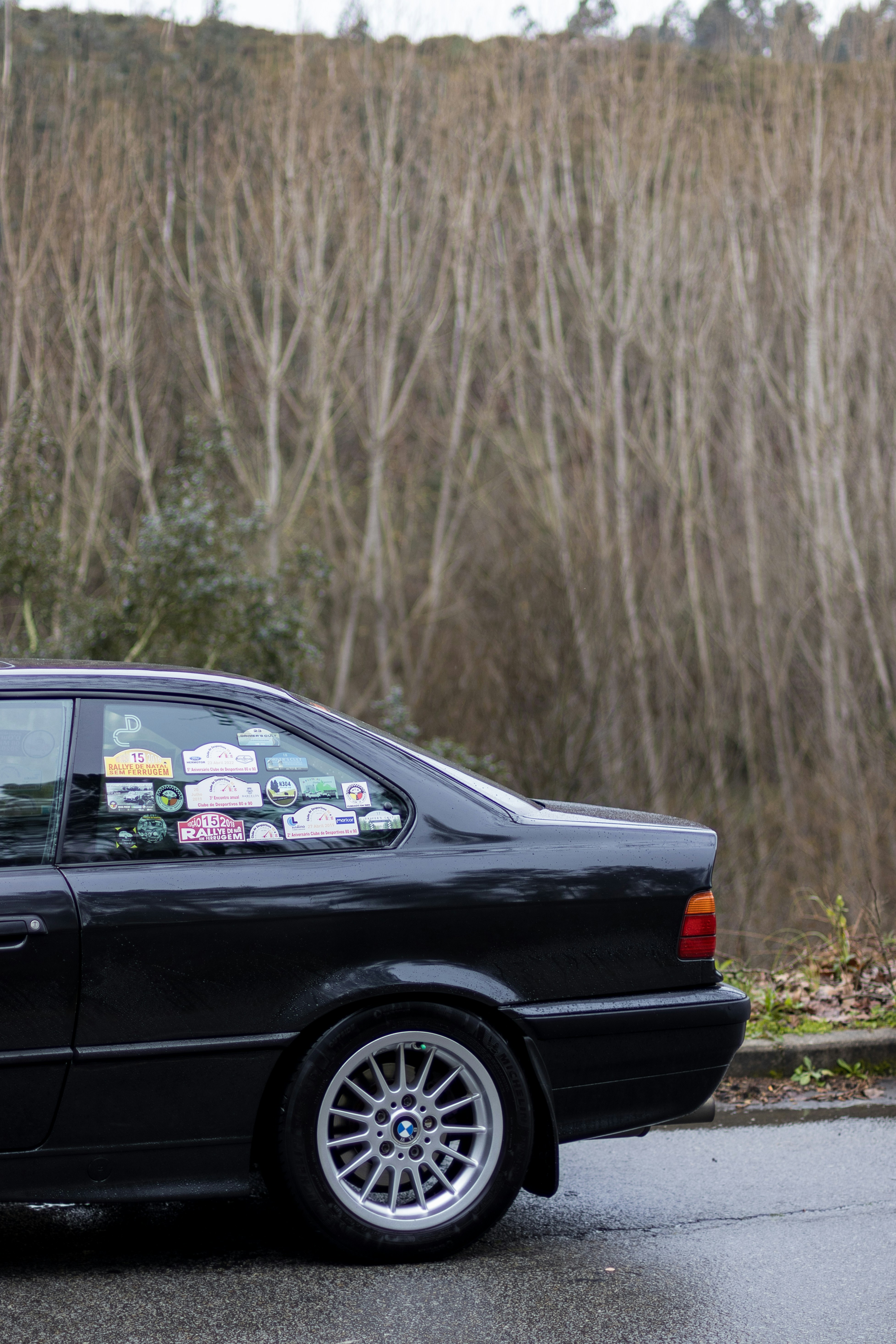 Stickered Sedan at the Edge of a Quiet Winter Road