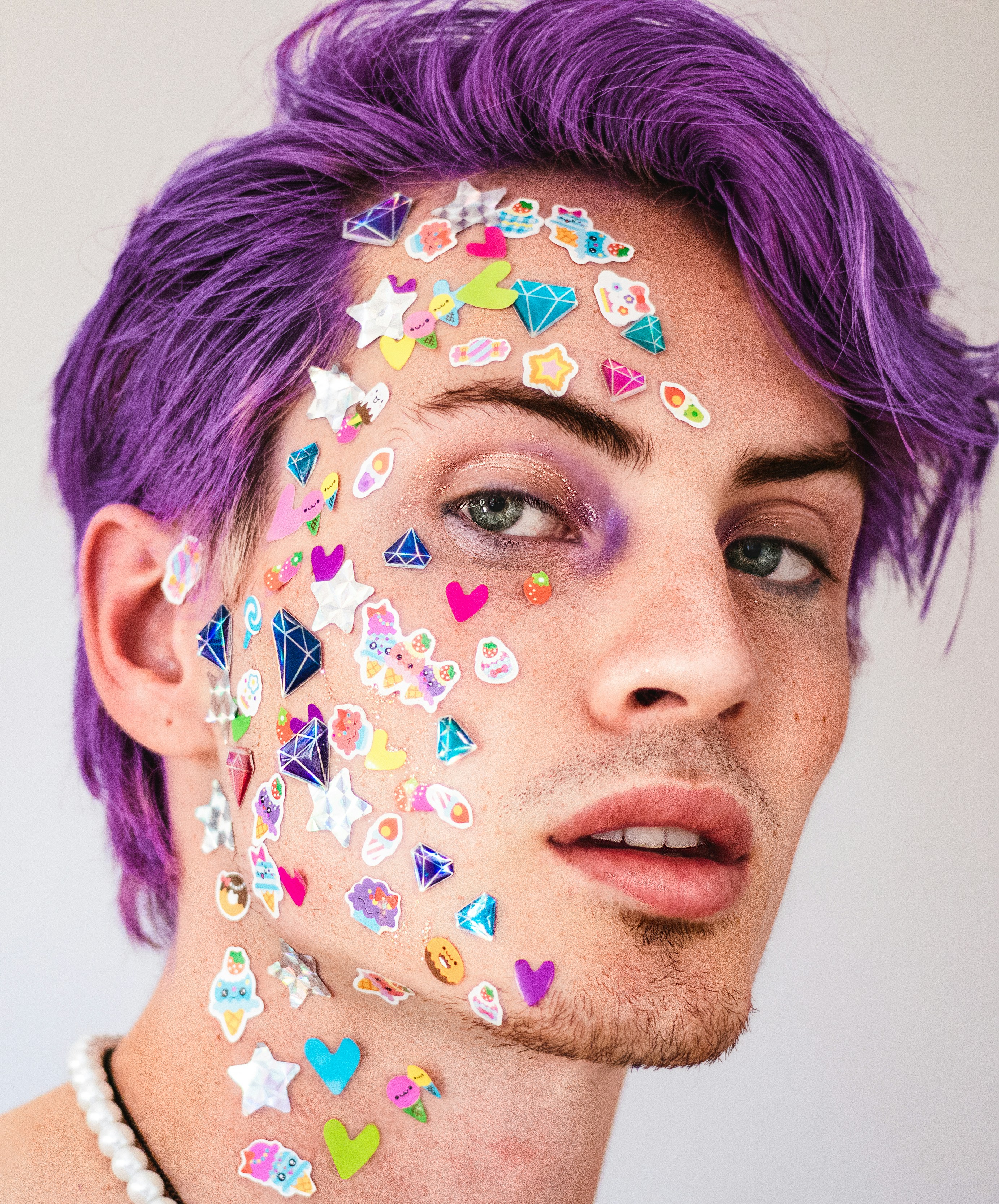 A man with purple hair and lots of stickers on his face photo – Free ...