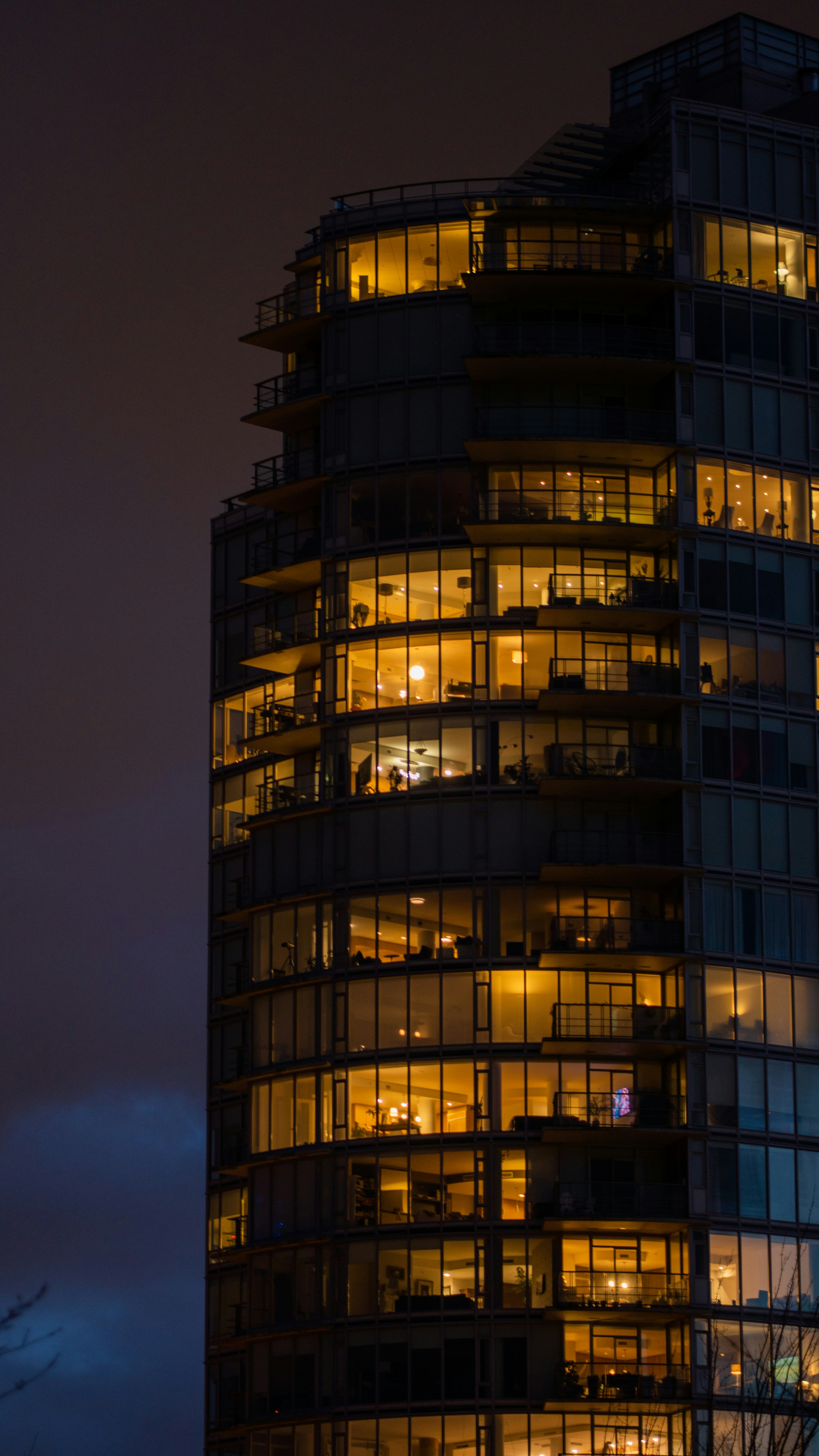 a very tall building with many windows lit up at night