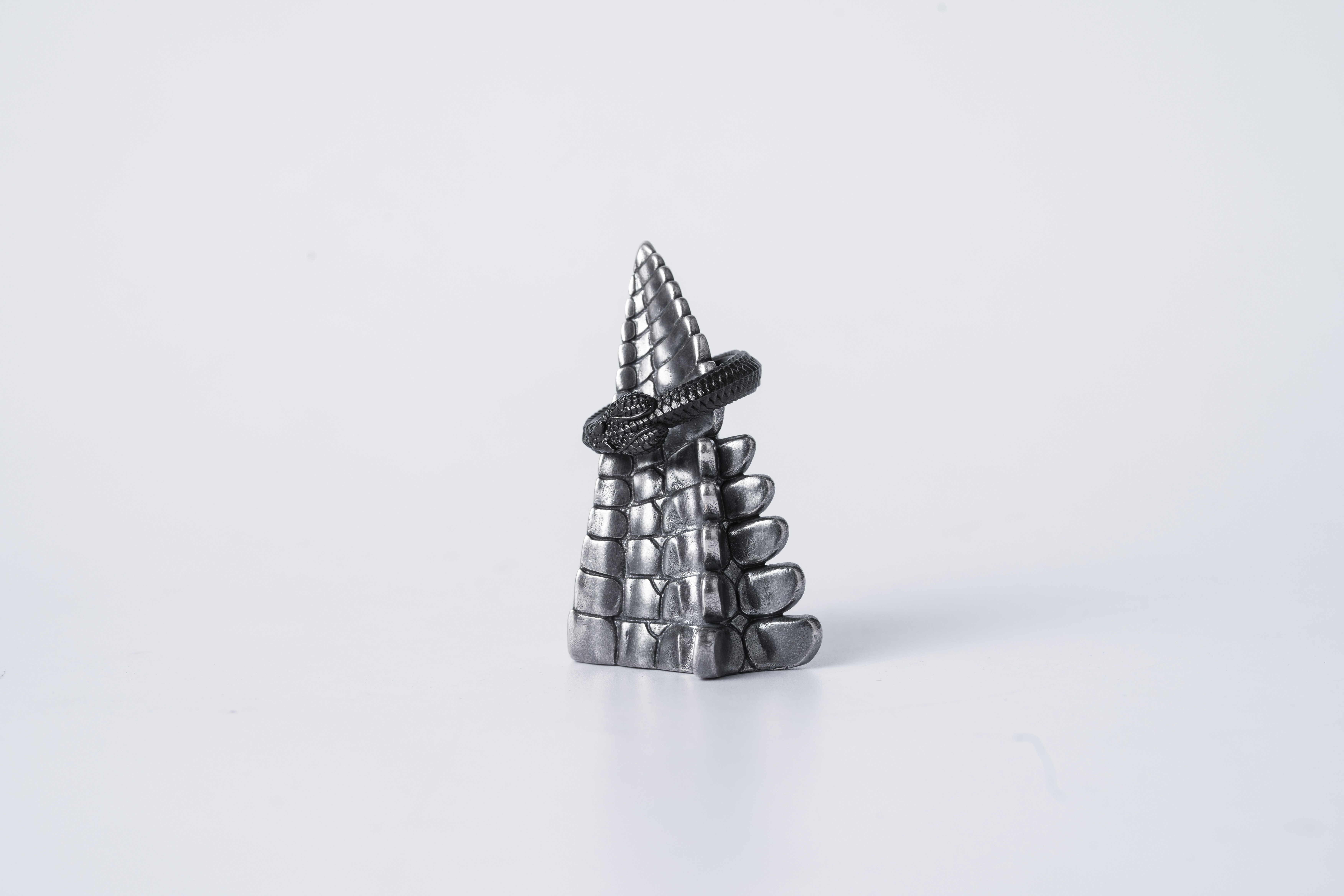 Stacked Spiral: A Silver Screw Tower in Quiet Studio Light