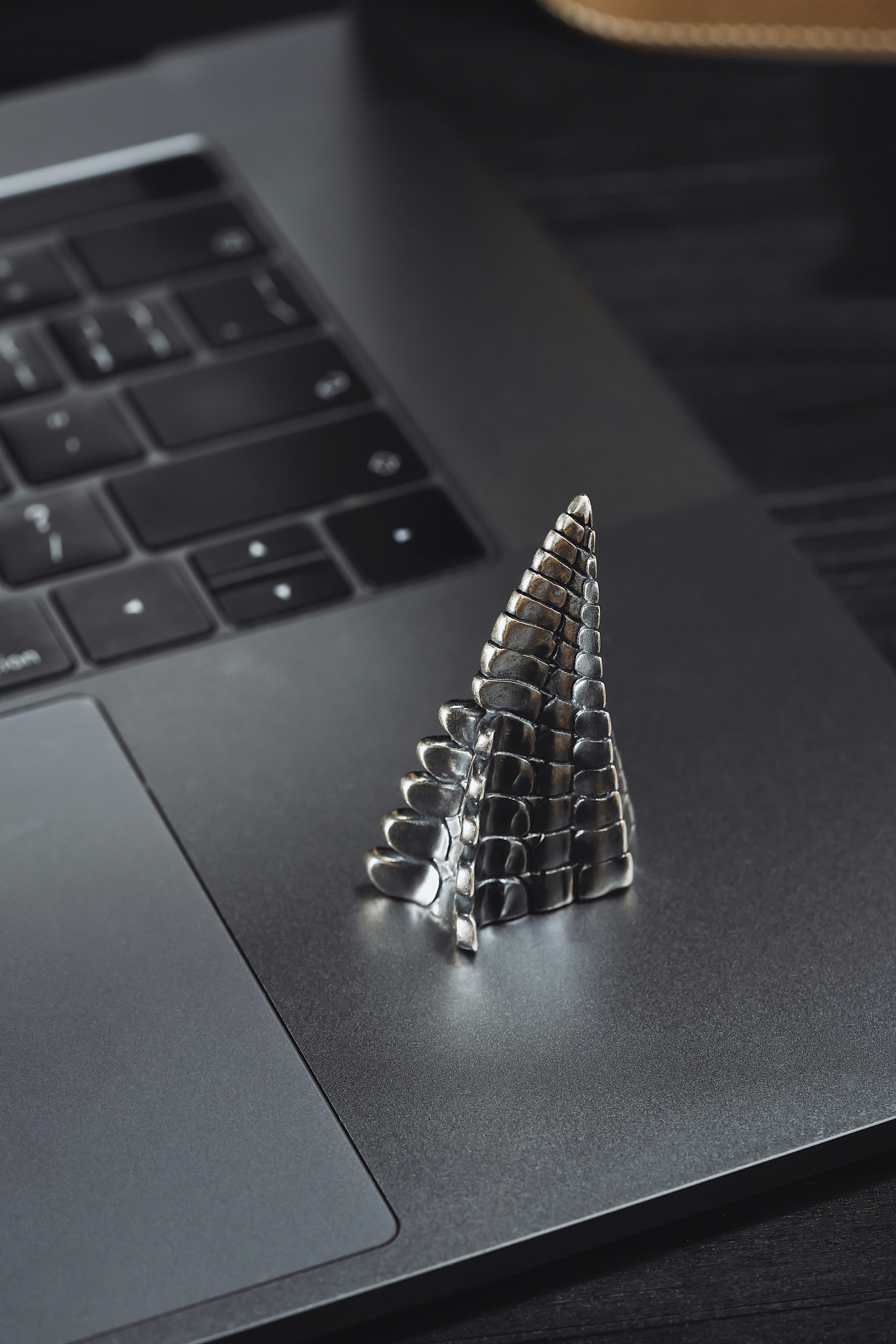 A small metal pyramid sitting on top of a laptop keyboard photo – Free ...