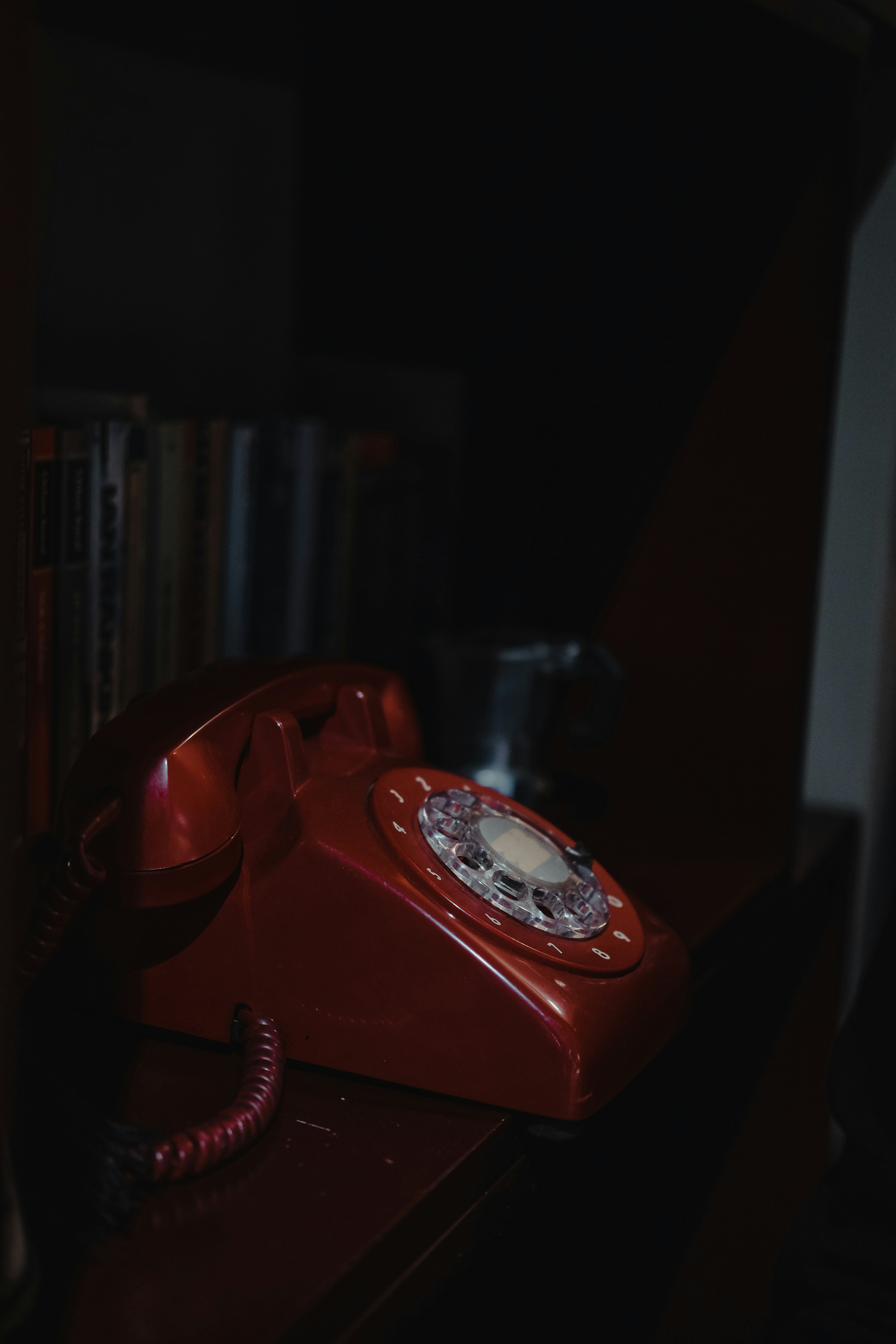 Red Rotary on a Dim Desk: A Quiet Study Moment