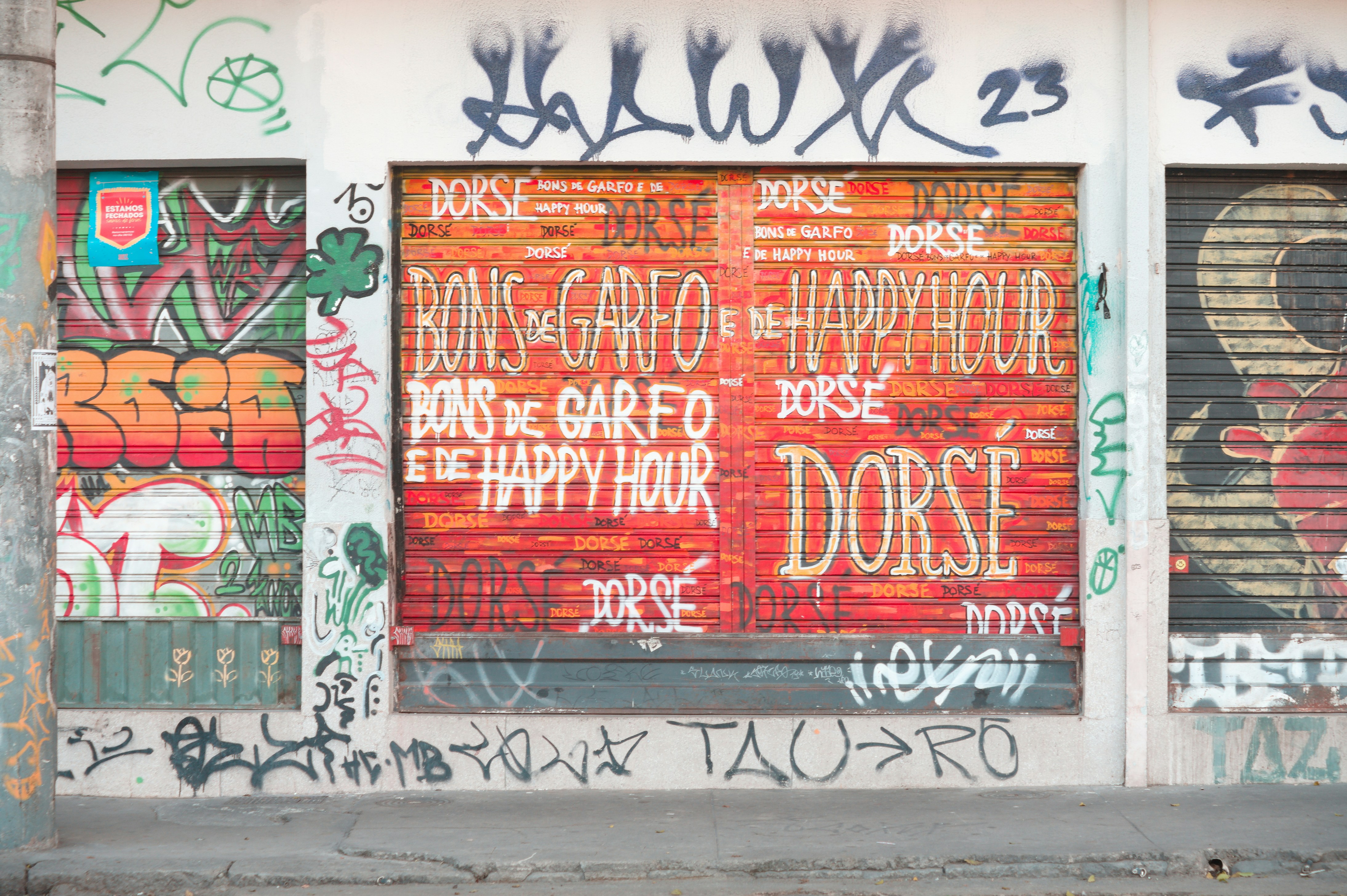 a wall covered in graffiti next to a fire hydrant