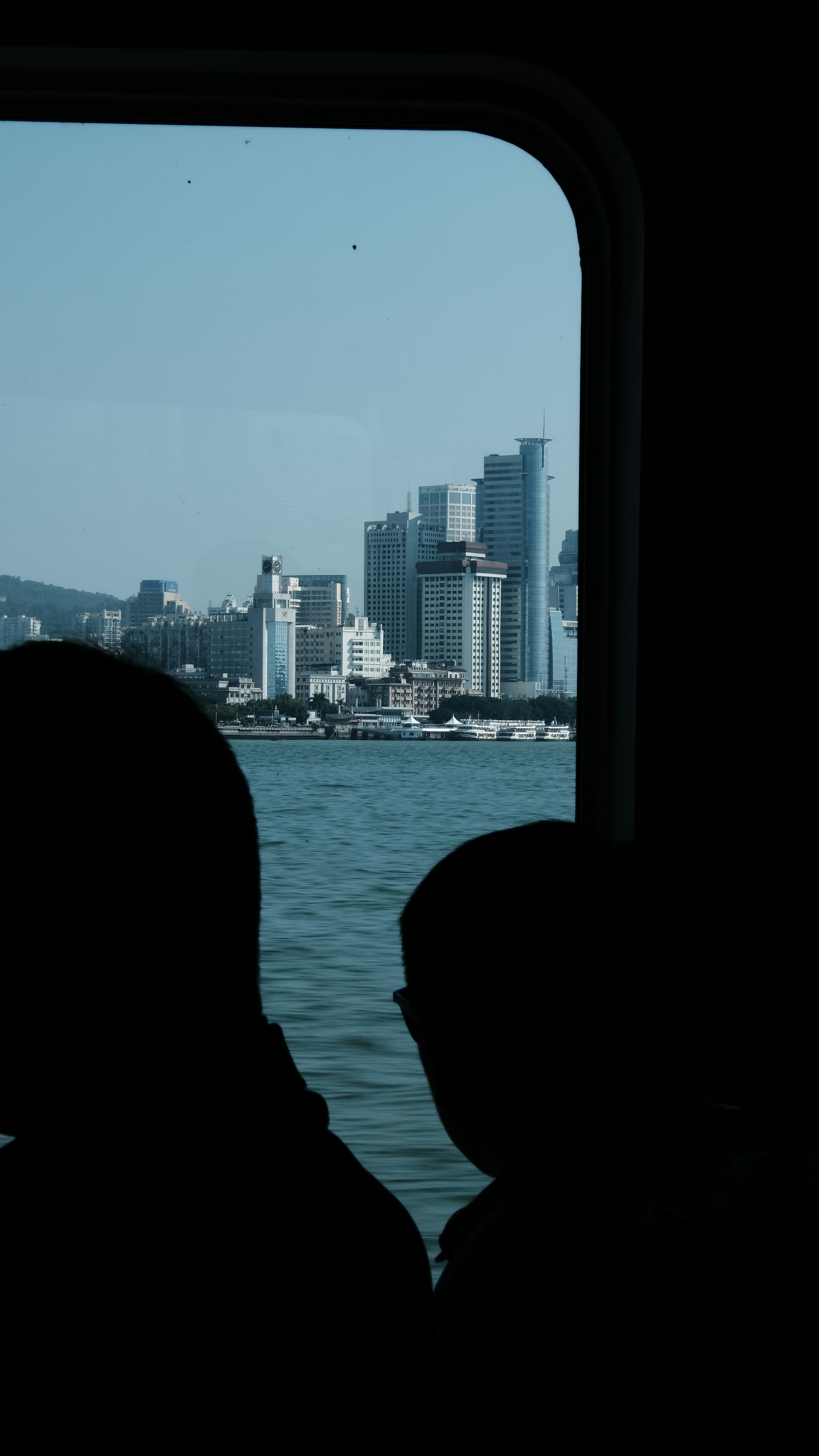 Two people looking out a window at a city photo – Free City Image on ...