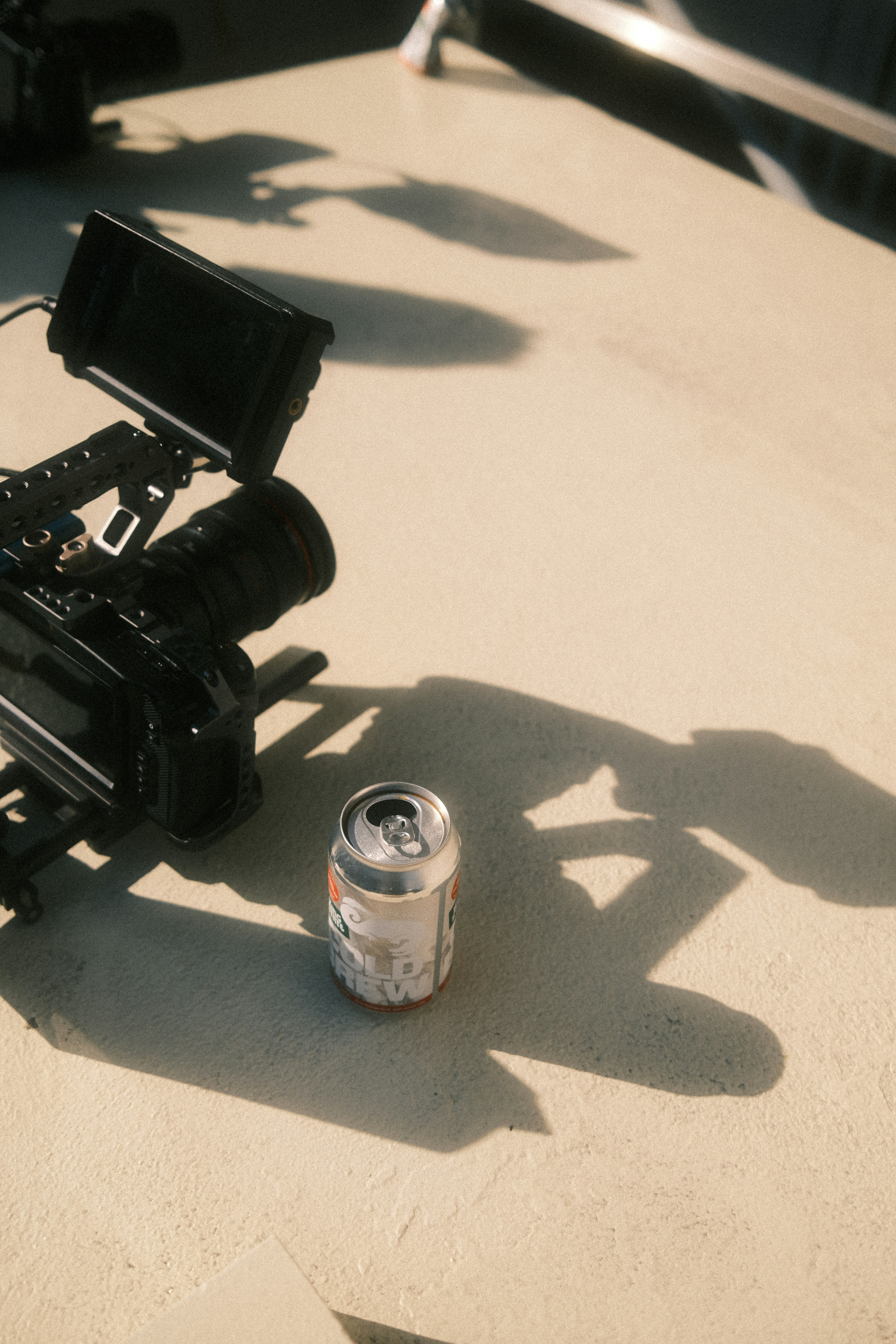 Shadows and Steel: A Studio Rig Beside an Open Can