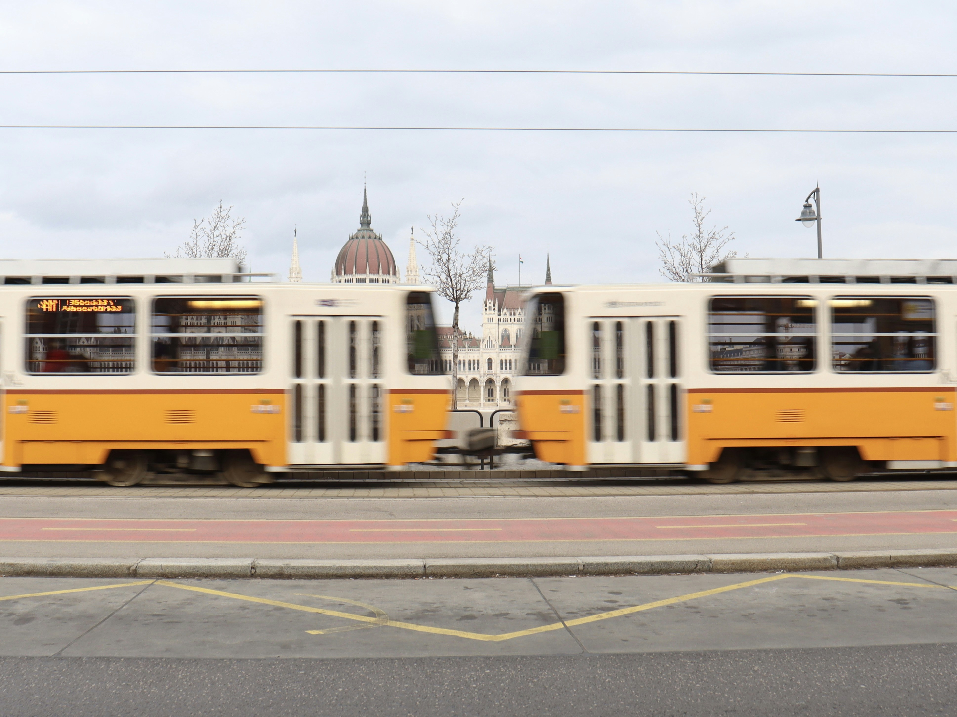Blurred Yellow Trams Glide Through a Domed Cityscape
