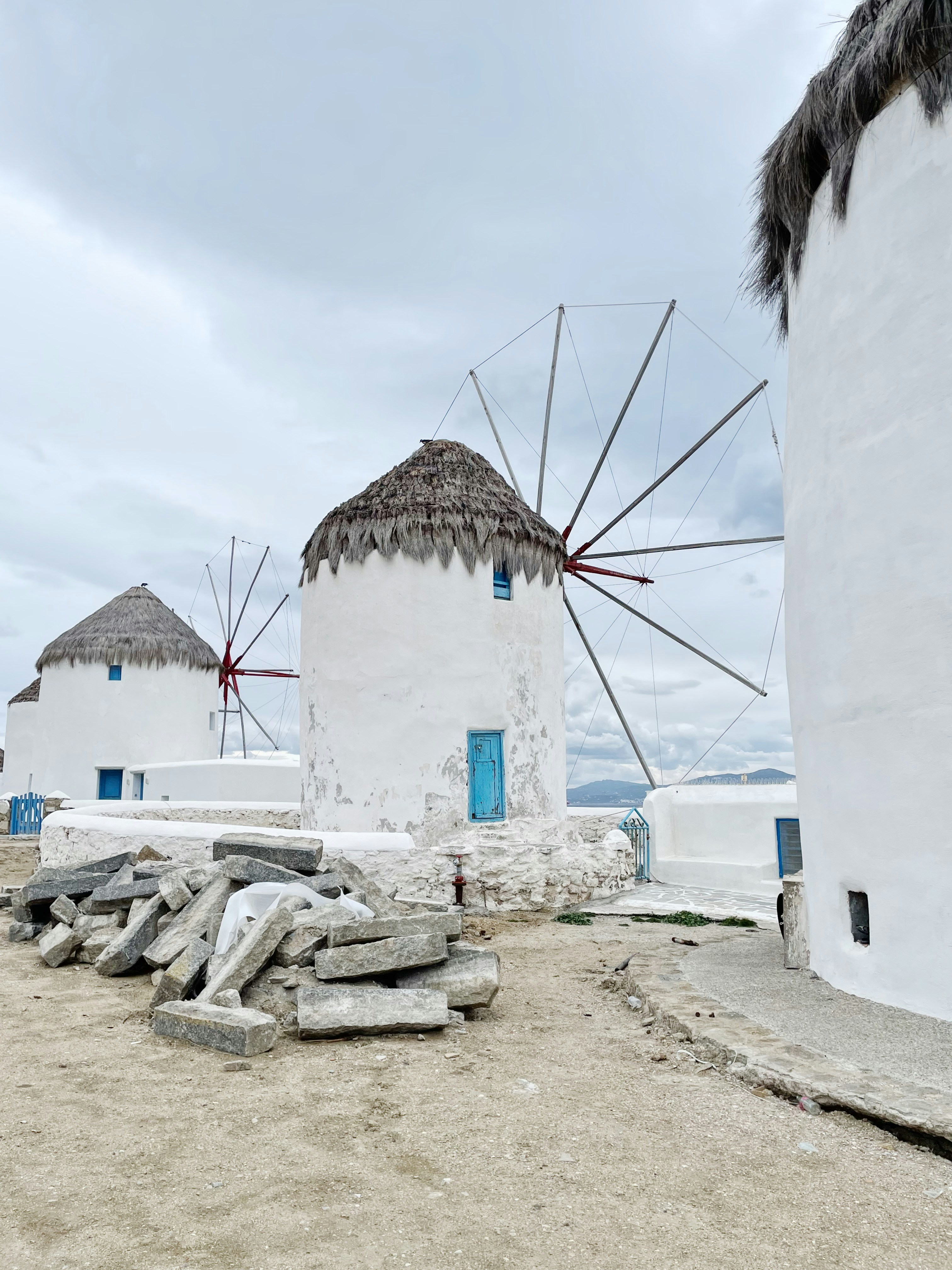 A couple of white windmills sitting next to each other photo – Free ...