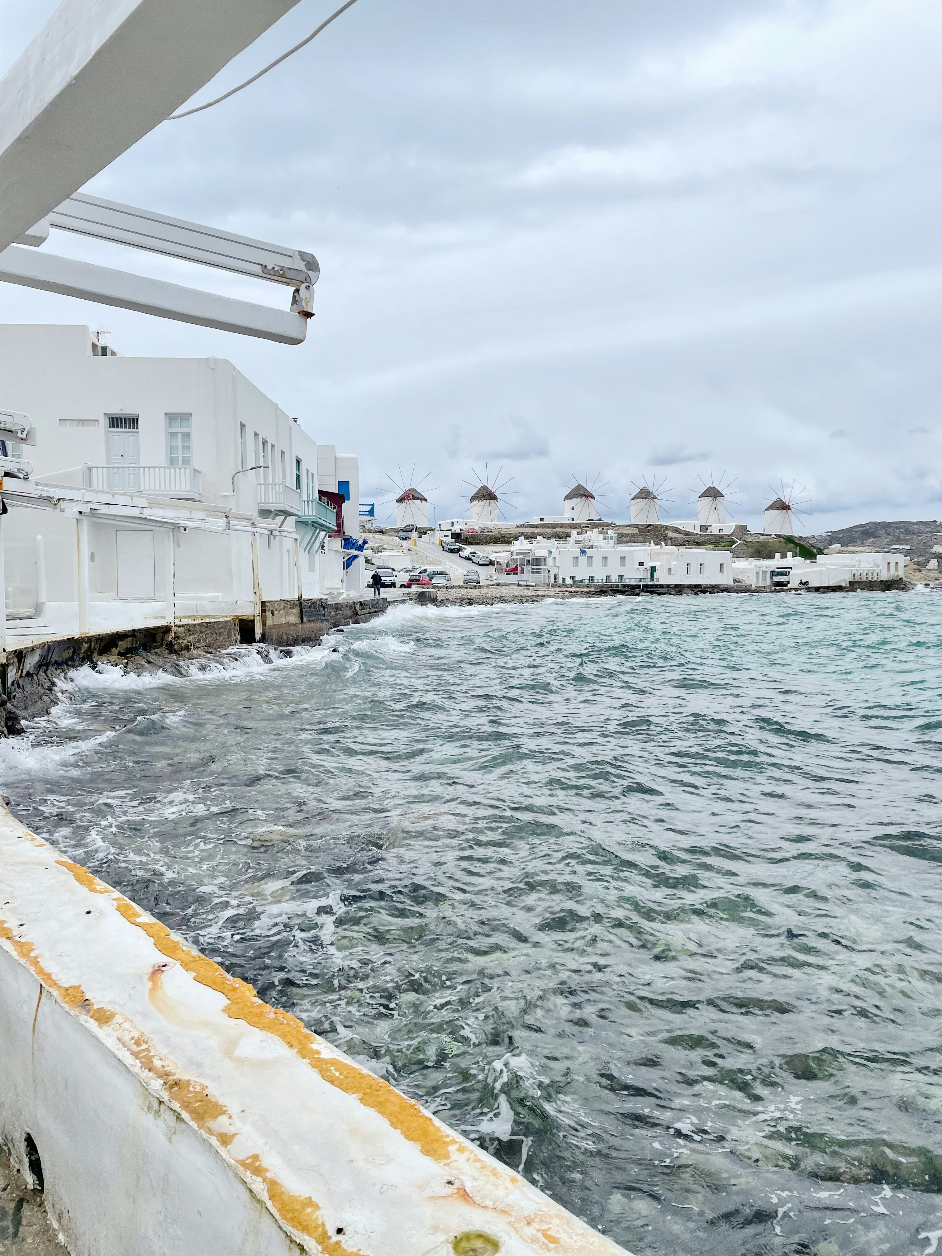 White Harborfront Under a Pale Sky: A Quiet Aegean Edge