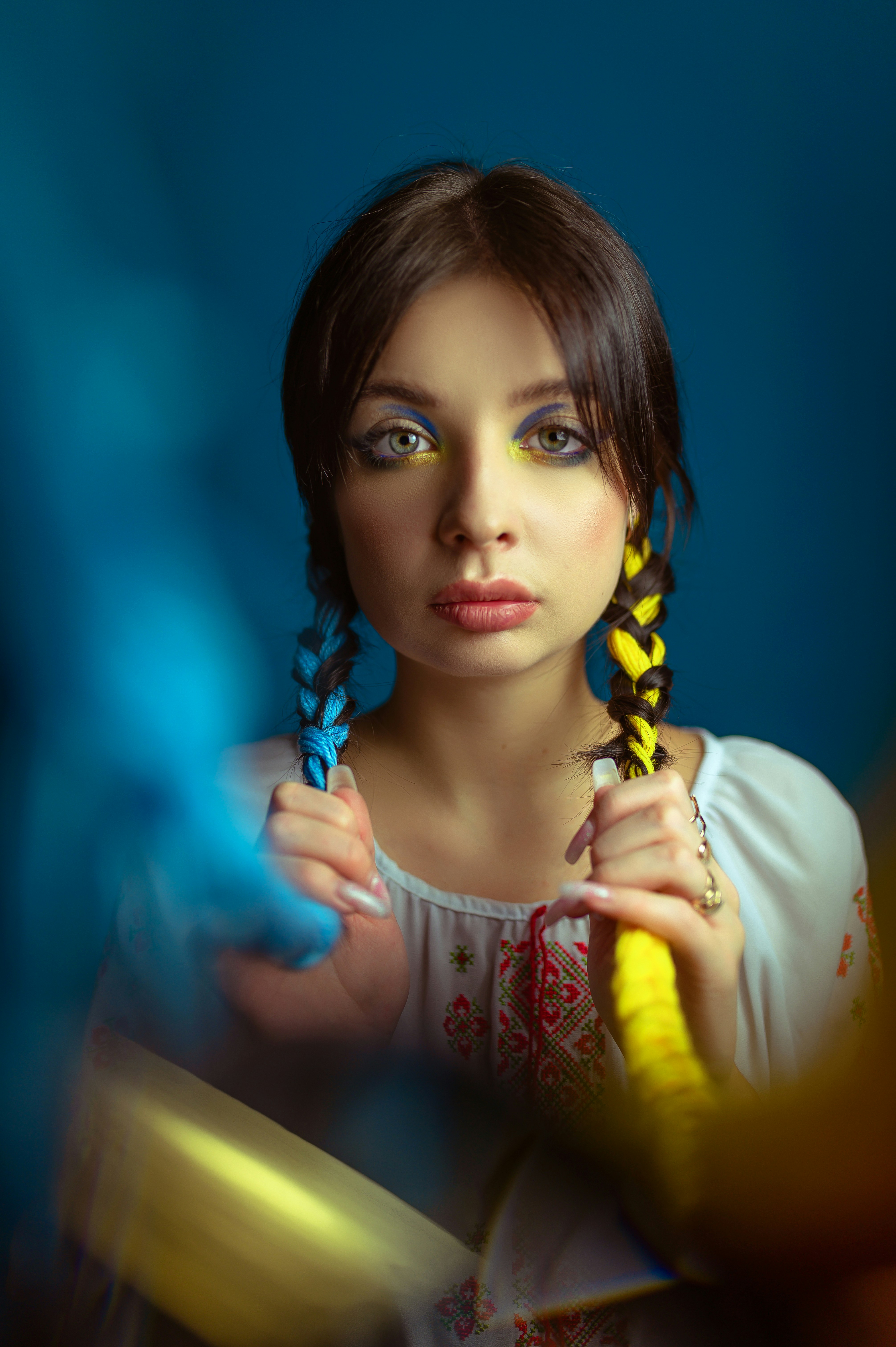 A woman with blue and yellow makeup holding a banana photo – Free Face ...