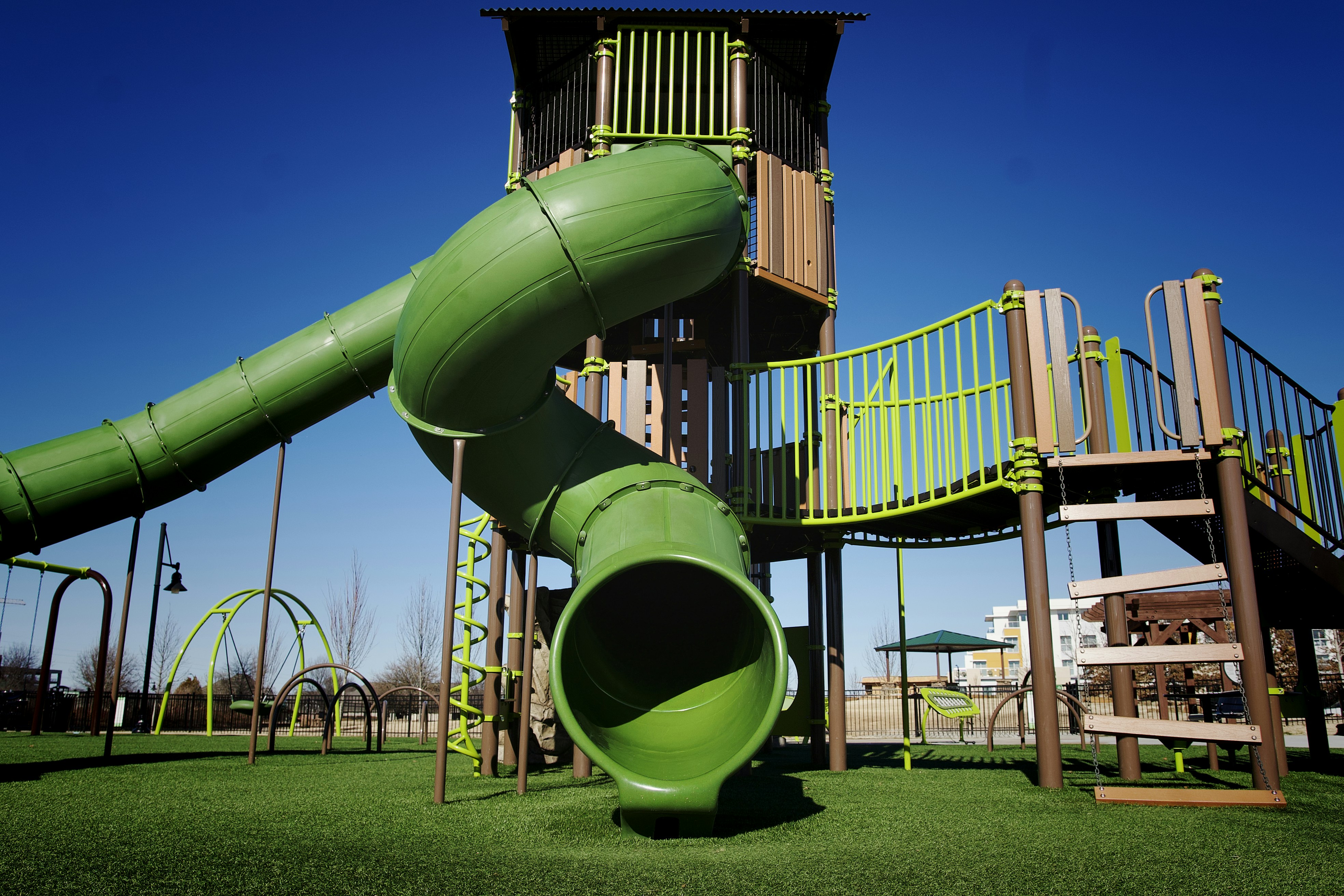 A playground with a green slide and a green slide photo – Free Blue ...