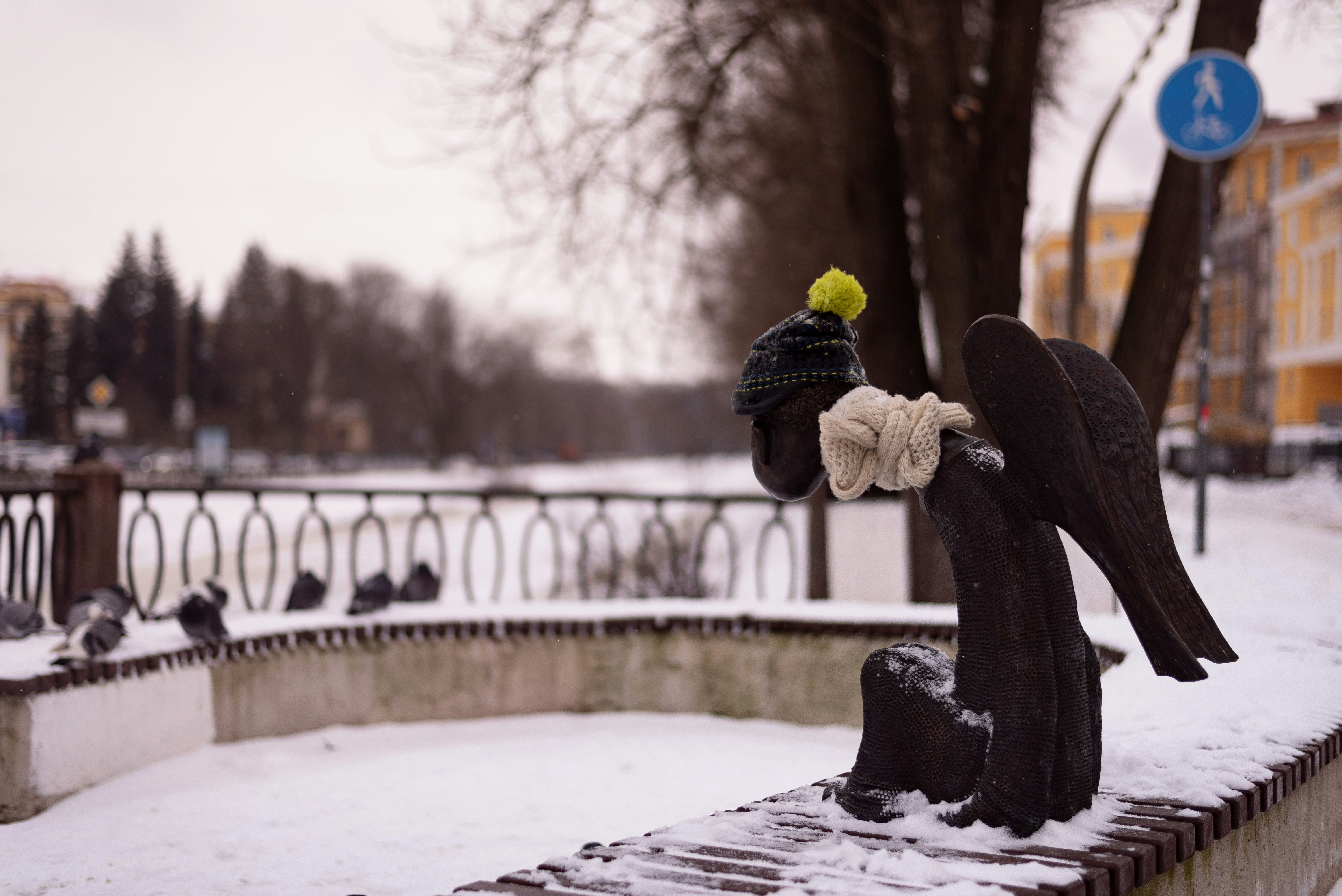 a statue of a bird with a hat on it's head