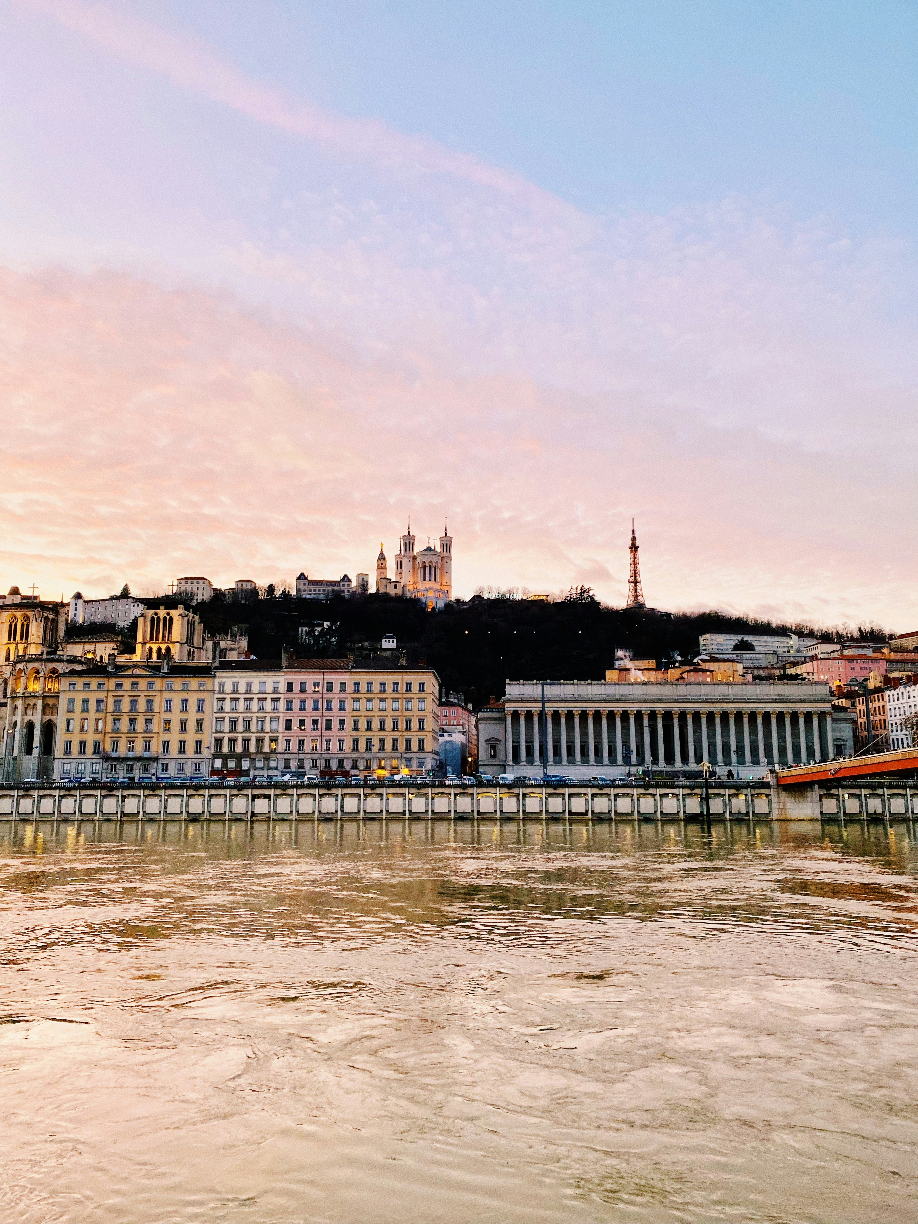 a river with a bridge and a city in the background