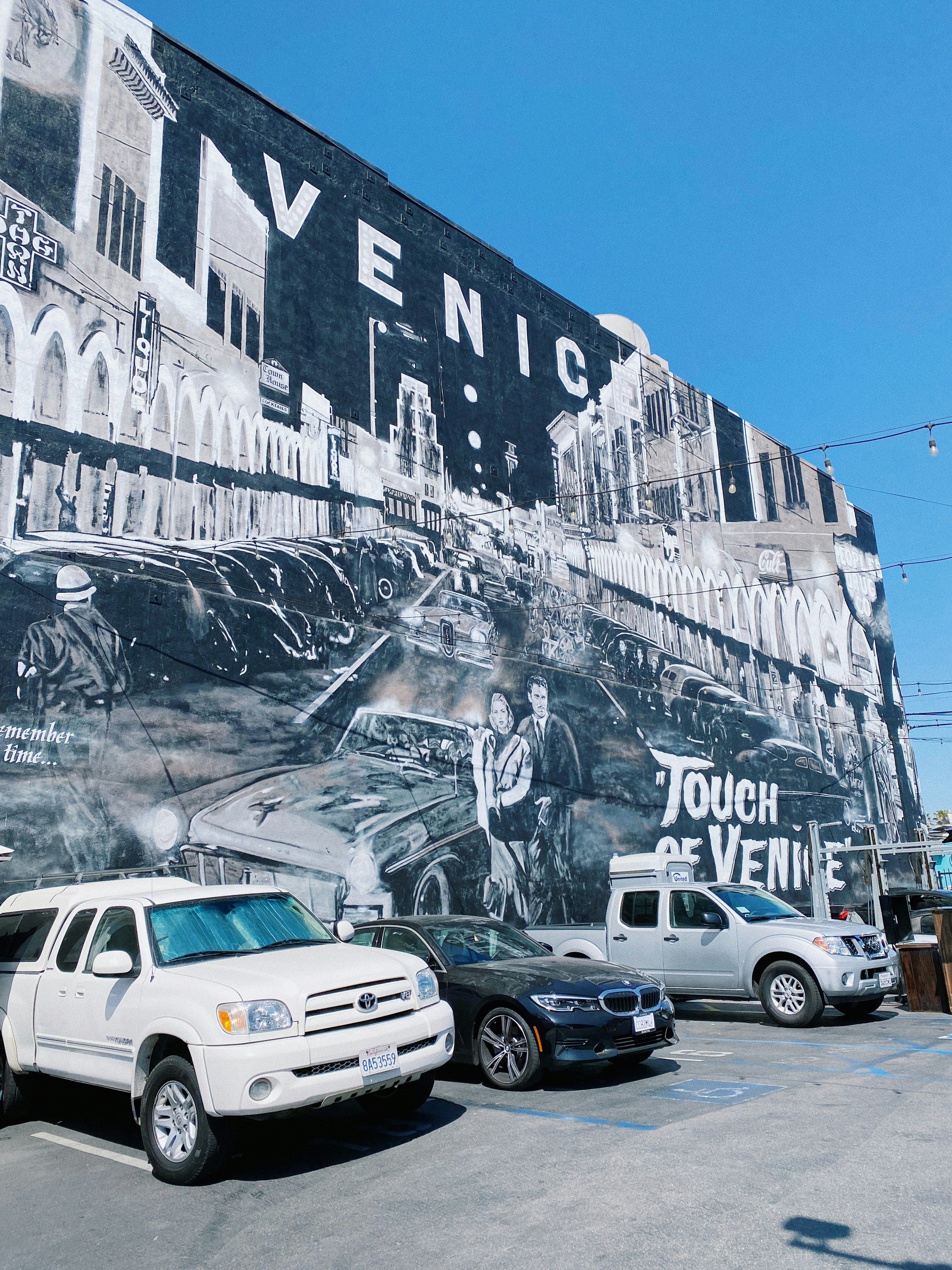 Urban Canvas: A Roadside Gallery under a Clear Blue Sky