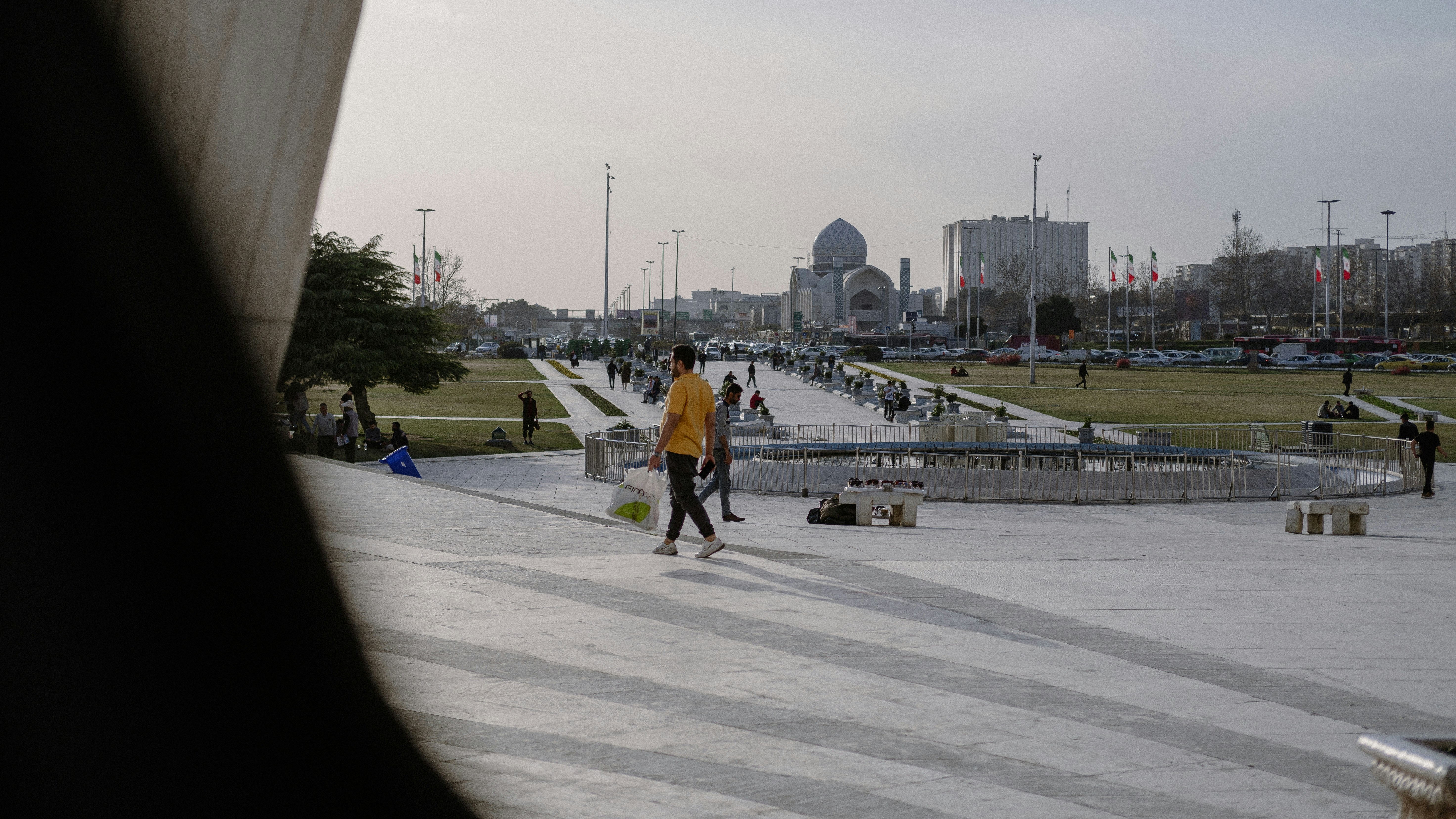 Orange-Clad Crossing: A Quiet Moment in a City Plaza