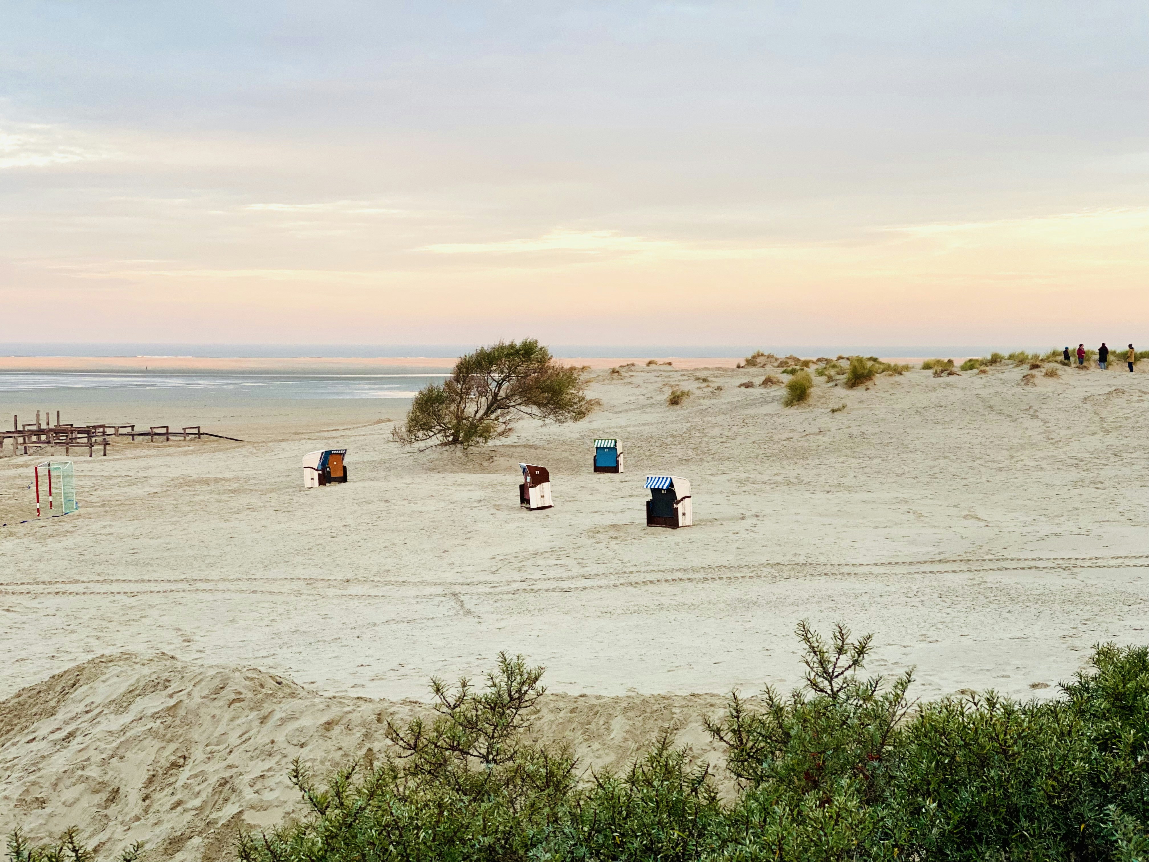 Dune Shadows and Colorful Cabins: Quiet Beach Portrait